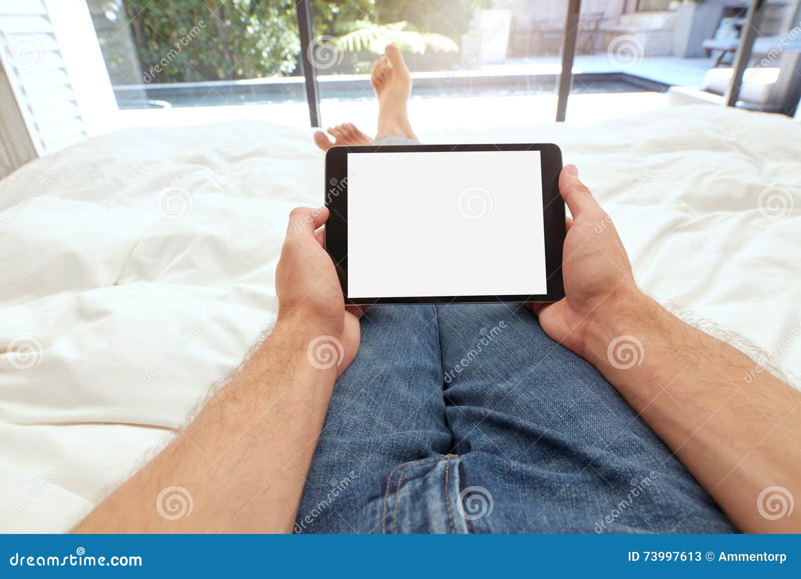 Man Using Touch Screen Computer on Bed Stock Image - Image of holding ...