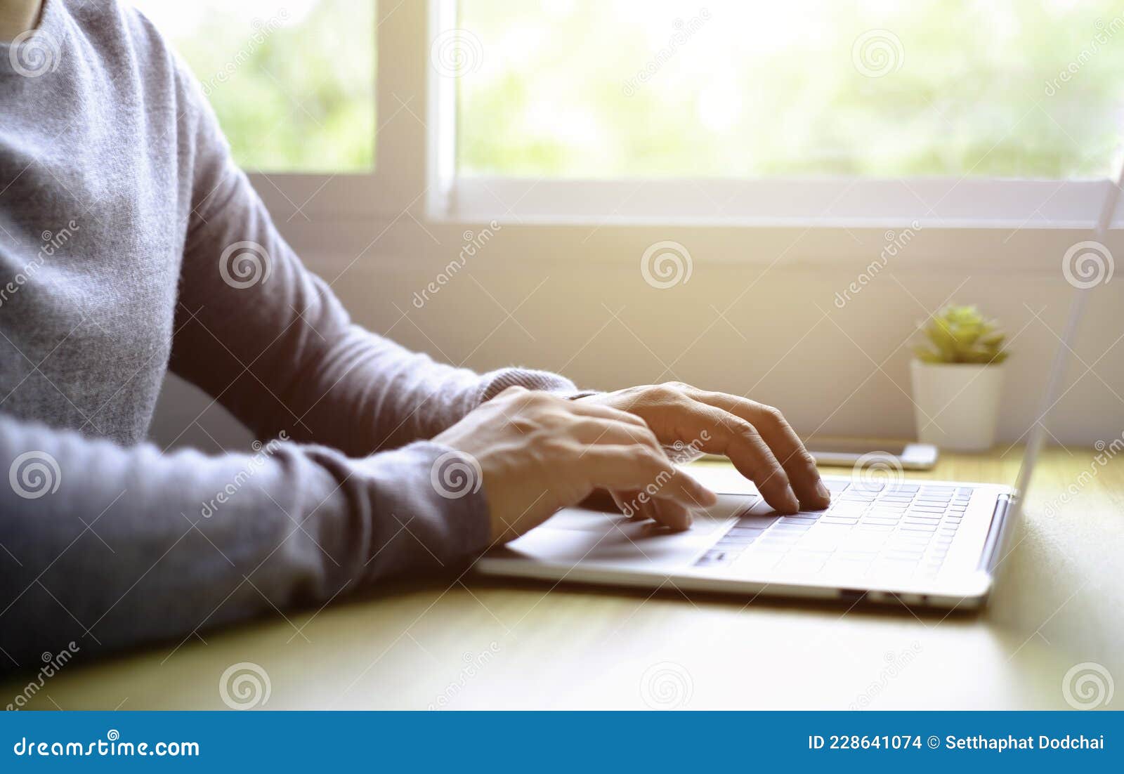 A Man Using and Typing Keyboard of Laptop Computer Communicates on ...