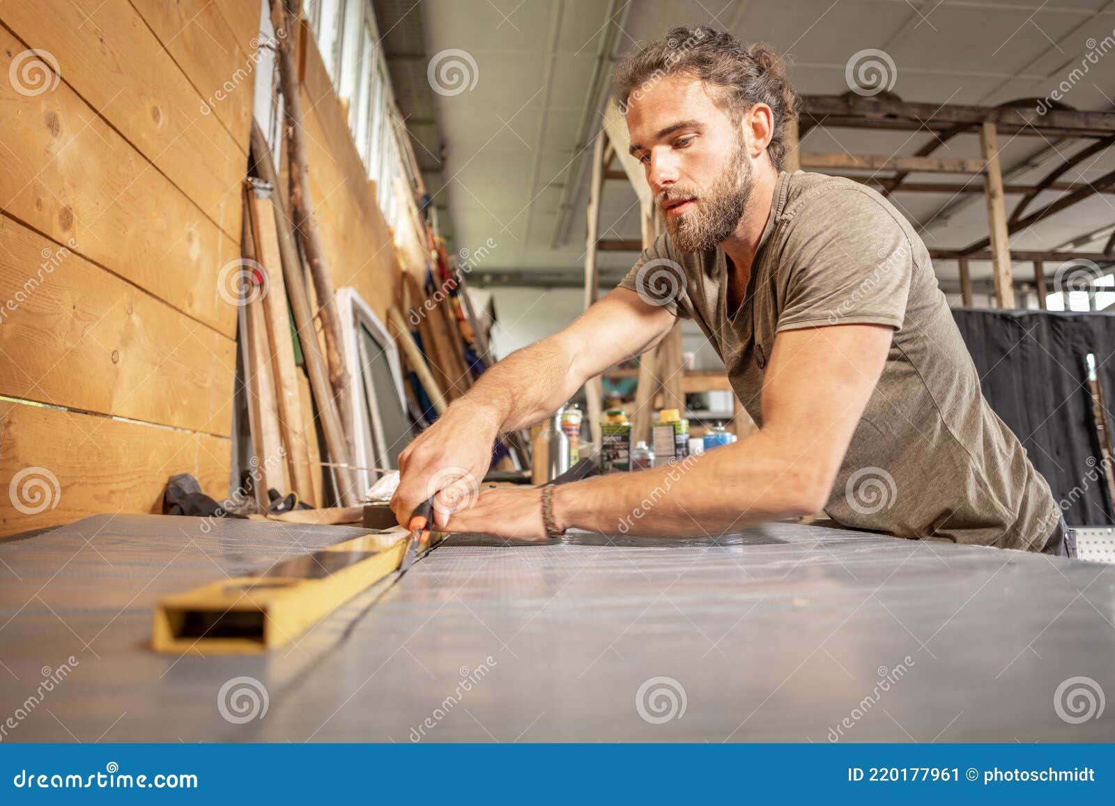 Man Using a Utility Knife on a Workbench Stock Image - Image of person ...