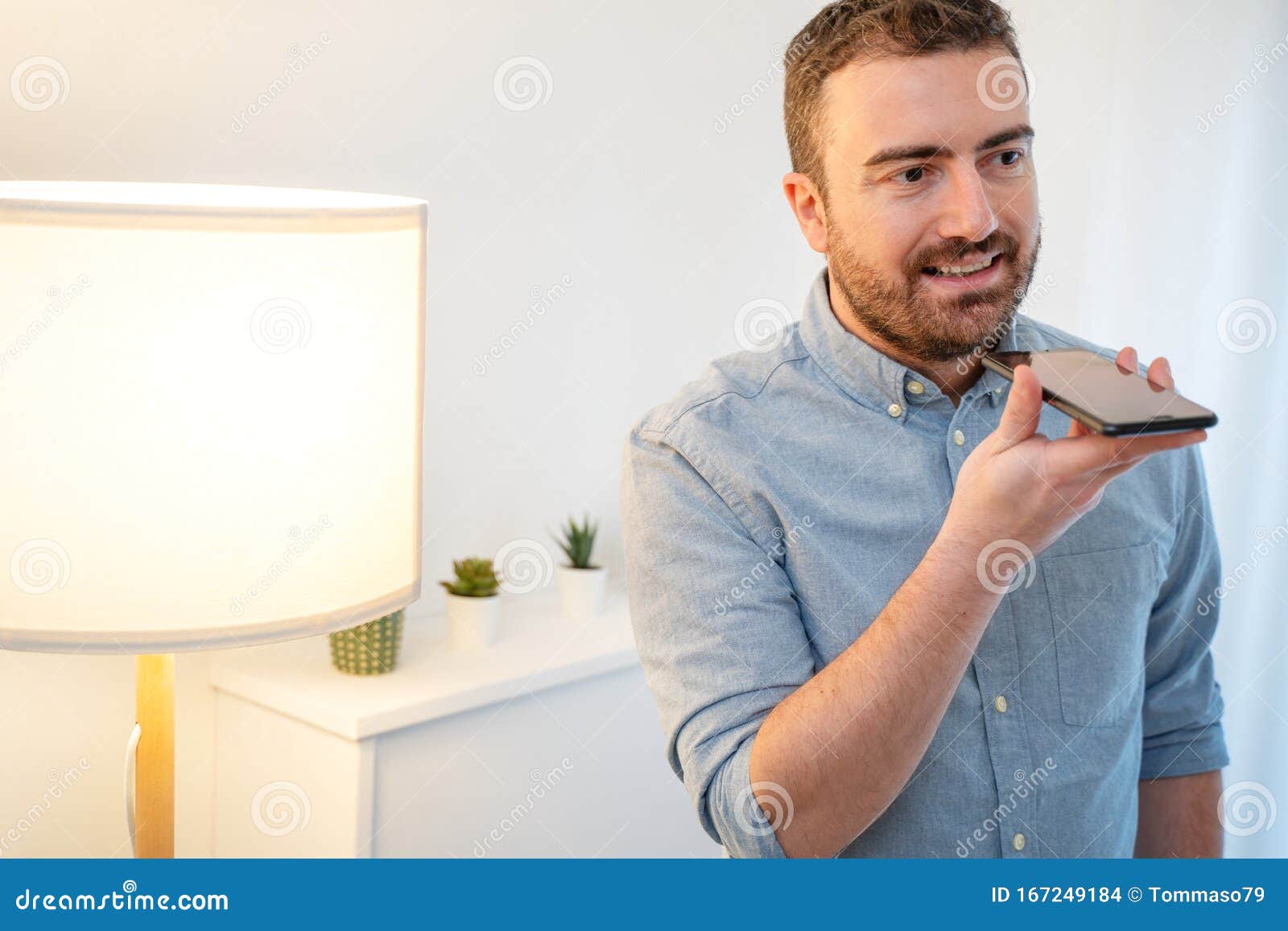 Man Using Virtual Assistant and Smart Speaker at Home Stock Photo ...