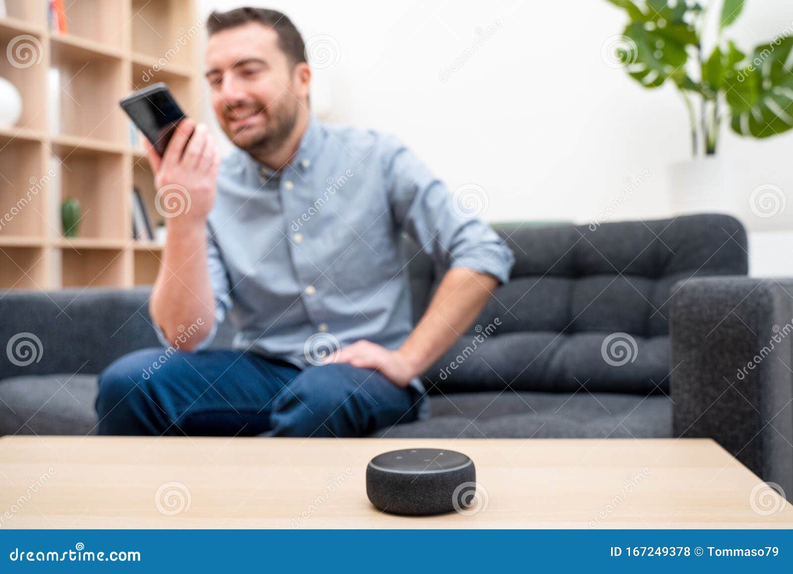Man Using Virtual Assistant and Smart Speaker at Home Stock Photo ...