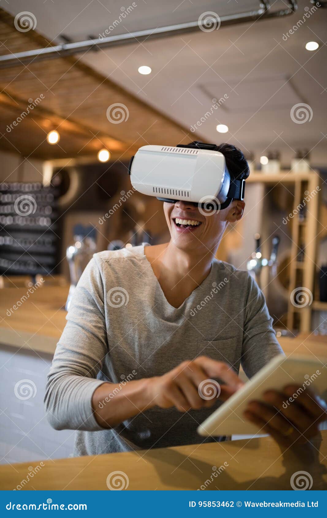 Man Using Virtual Reality Headset and Digital Tablet in Restaurant ... Man Using Virtual Reality Headset and Digital Tablet in Restaurant ...