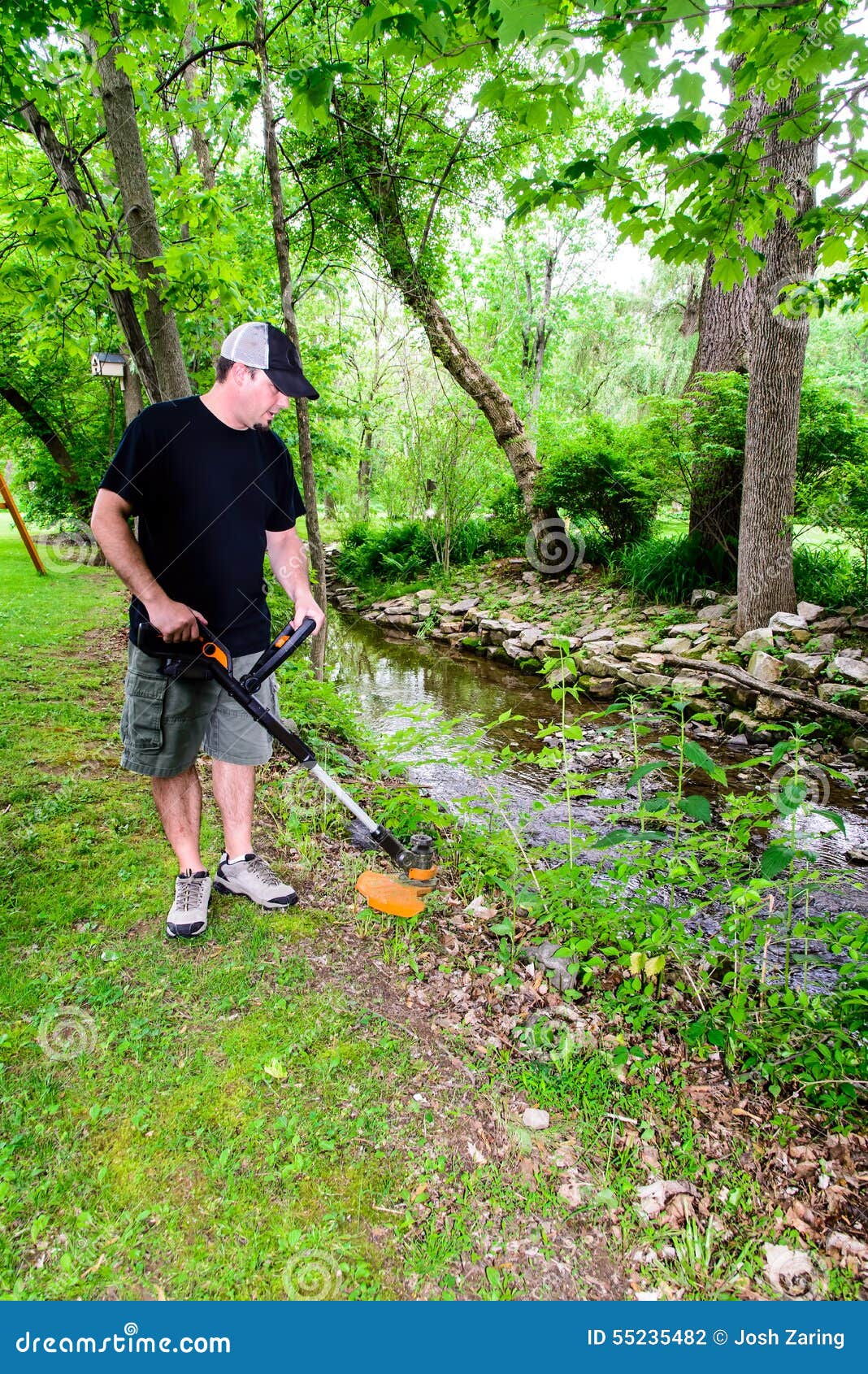 Man Using Weed Trimmer stock photo. Image of plain, grass - 55235482