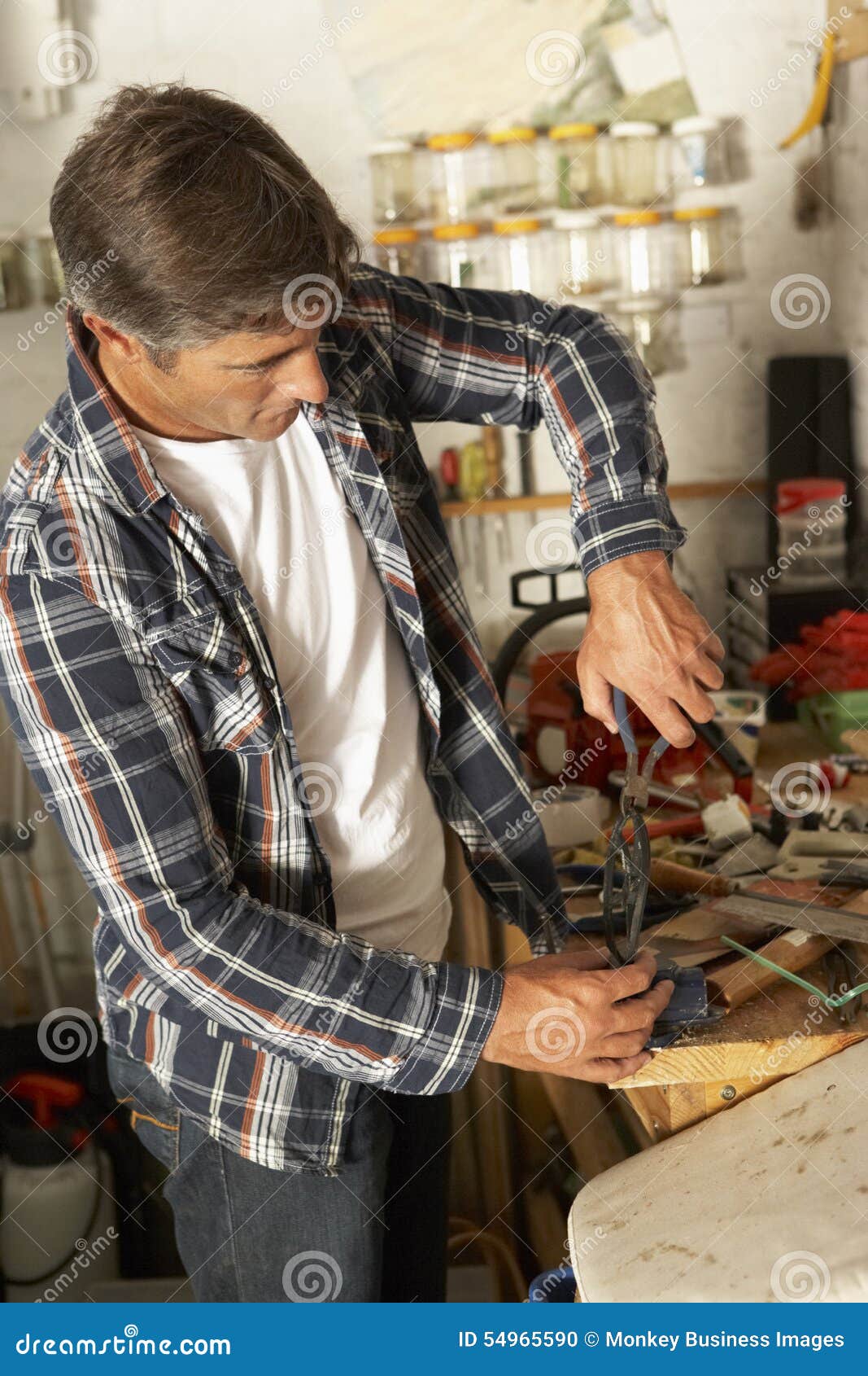 Man Using Workbench in Garage Stock Photo - Image of hobby, workbench ...