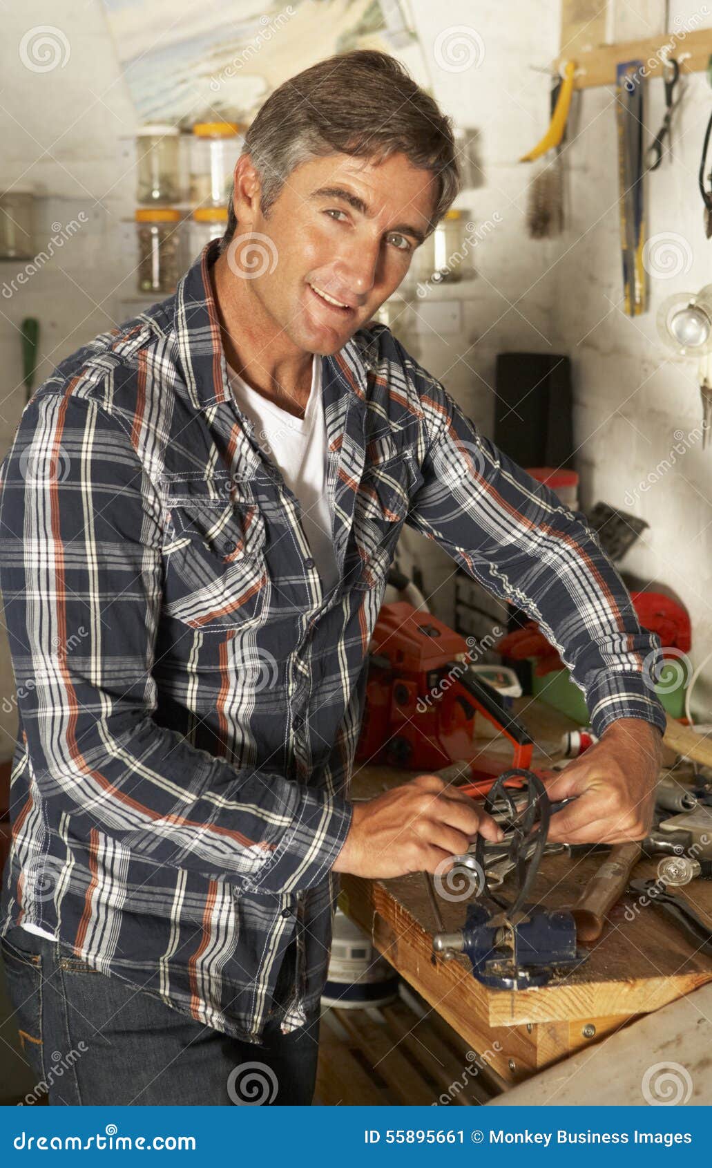 Man Using Workbench in Garage Stock Image - Image of male, fixing: 55895661