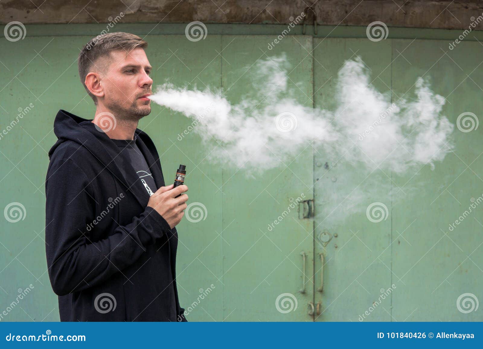 Man with Vape. Young Man Smoking an Electronic Cigarette Stock Photo ...