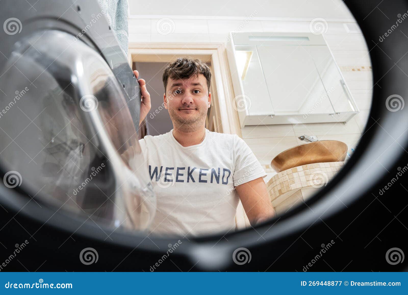Man View from Washing Machine Inside. Male Does Laundry daily Routine ...