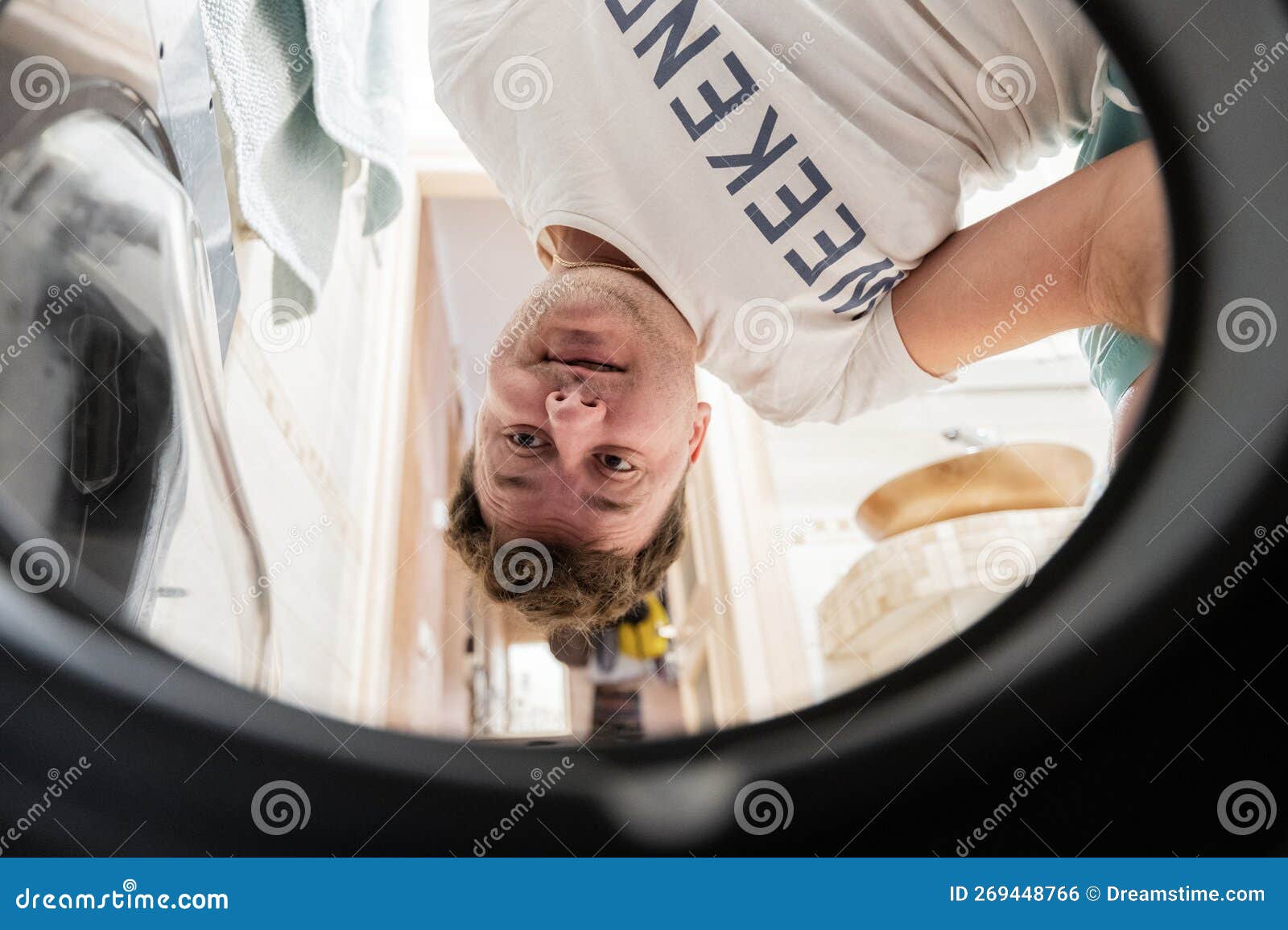 Man View from Washing Machine Inside. Male Does Laundry daily Routine ...