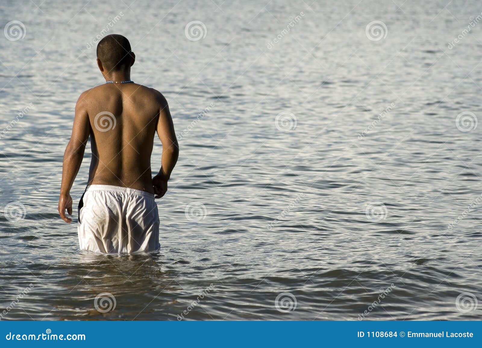 Man wading in lake or sea stock photo. Image of rear, slim - 1108684