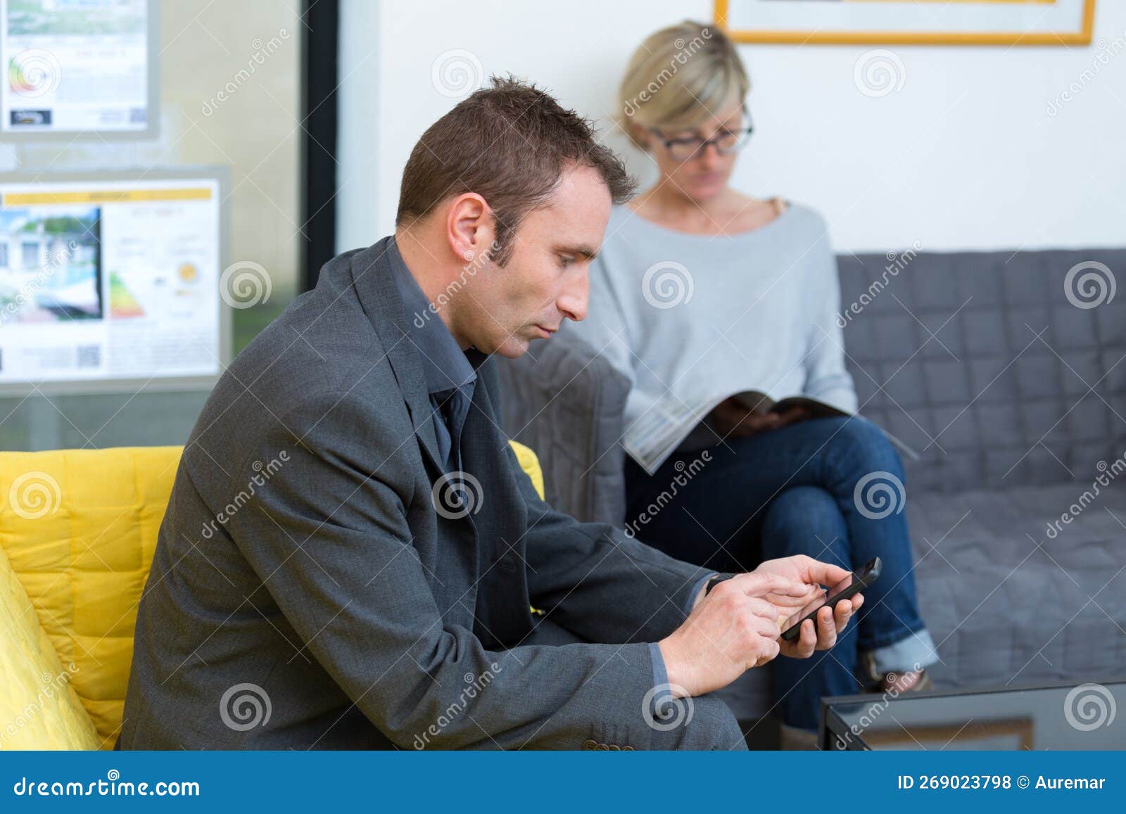 Man in Waiting Room Using Mobile Phone Stock Photo - Image of positive ...
