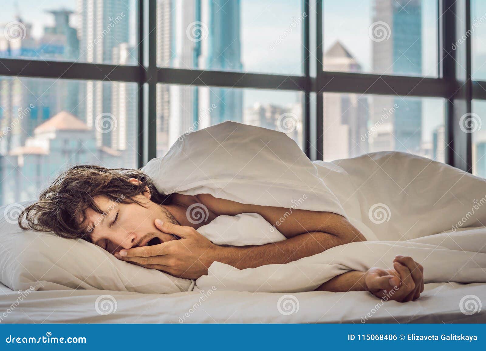 Man Wakes Up In The Morning In An Apartment In The Downtown Area Stock