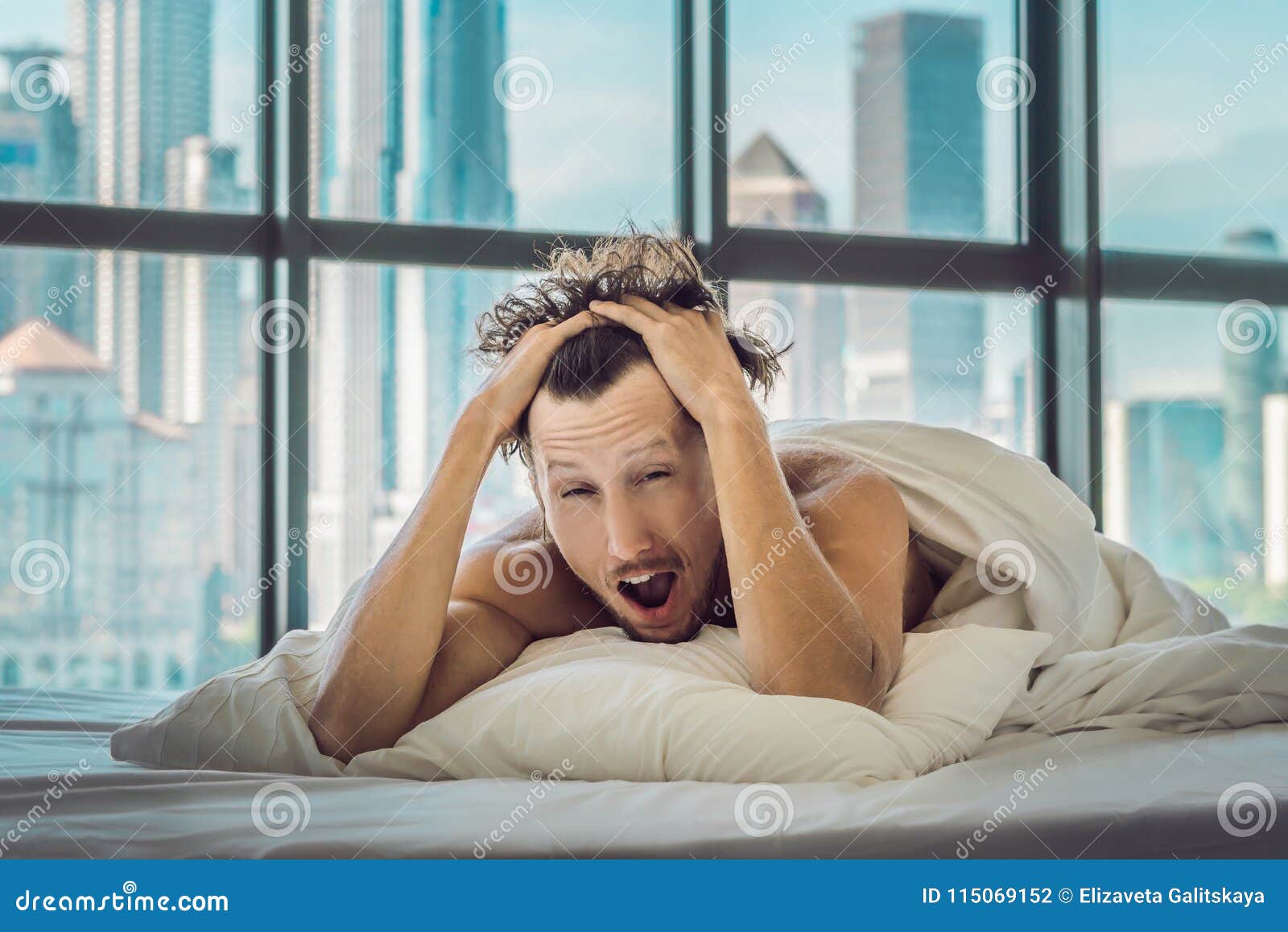 Man Wakes Up In The Morning In An Apartment In The Downtown Area Stock
