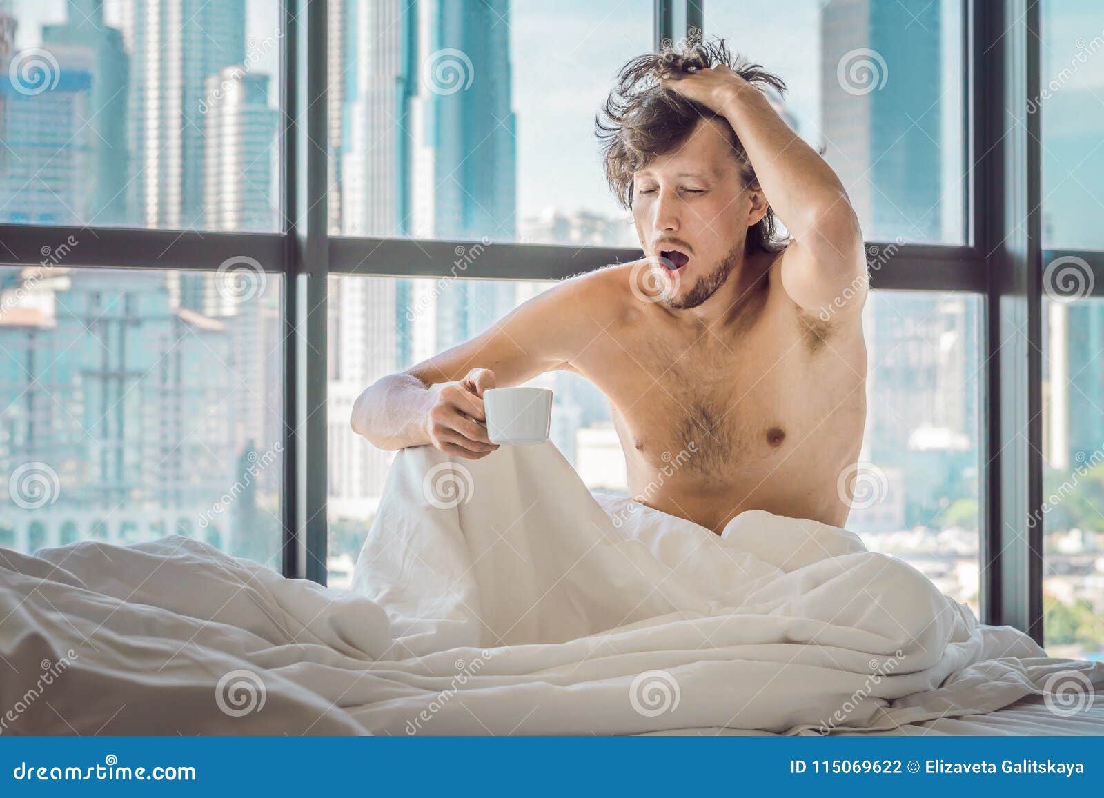 Man Wakes Up In The Morning In An Apartment In The Downtown Area Stock