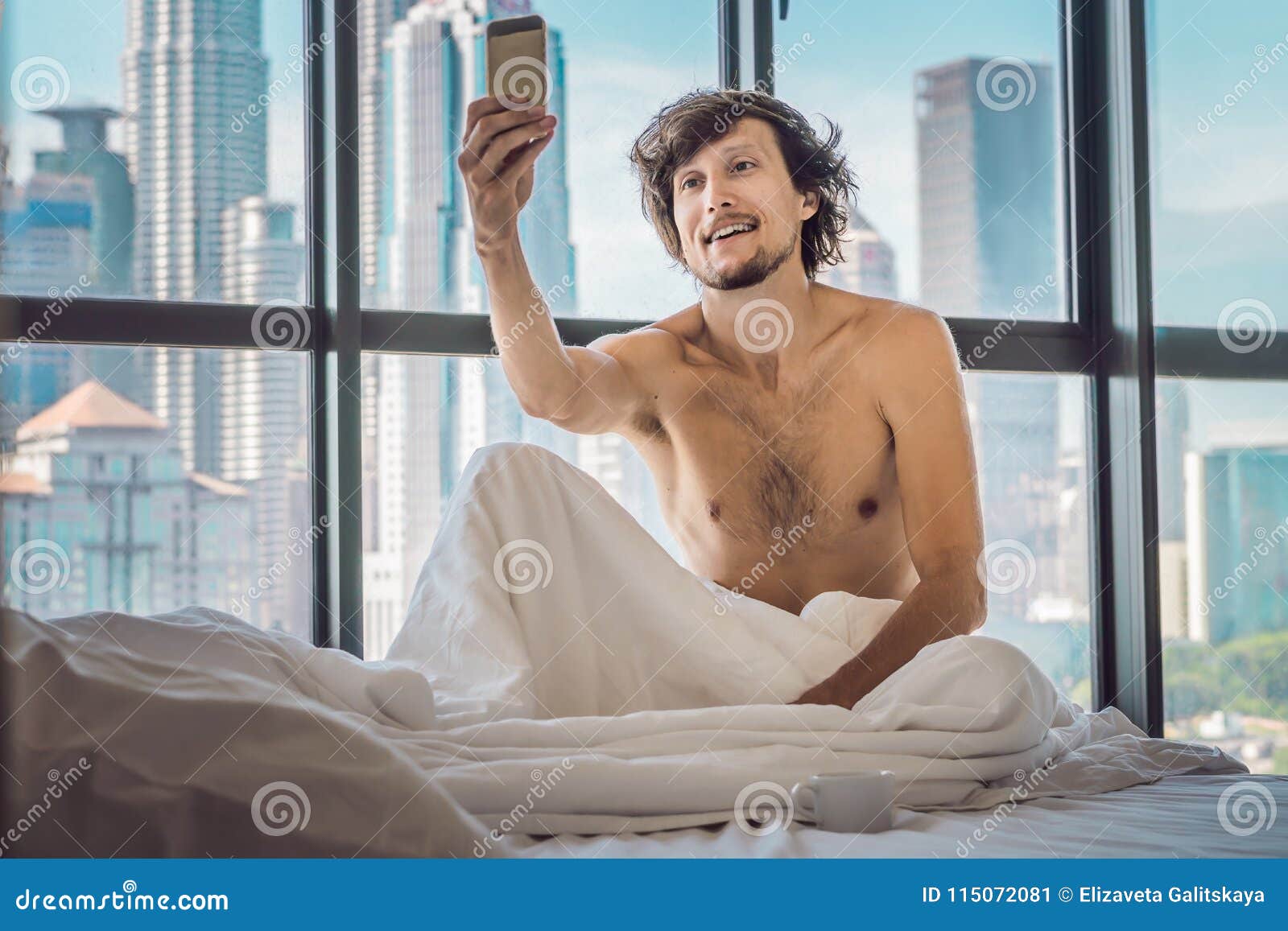 Man Wakes Up In The Morning In An Apartment In The Downtown Area Stock