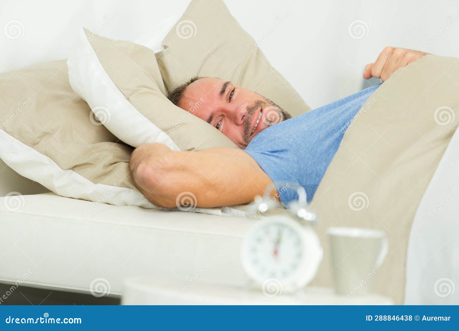 Man waking up with smile stock photo. Image of alarm - 288846438
