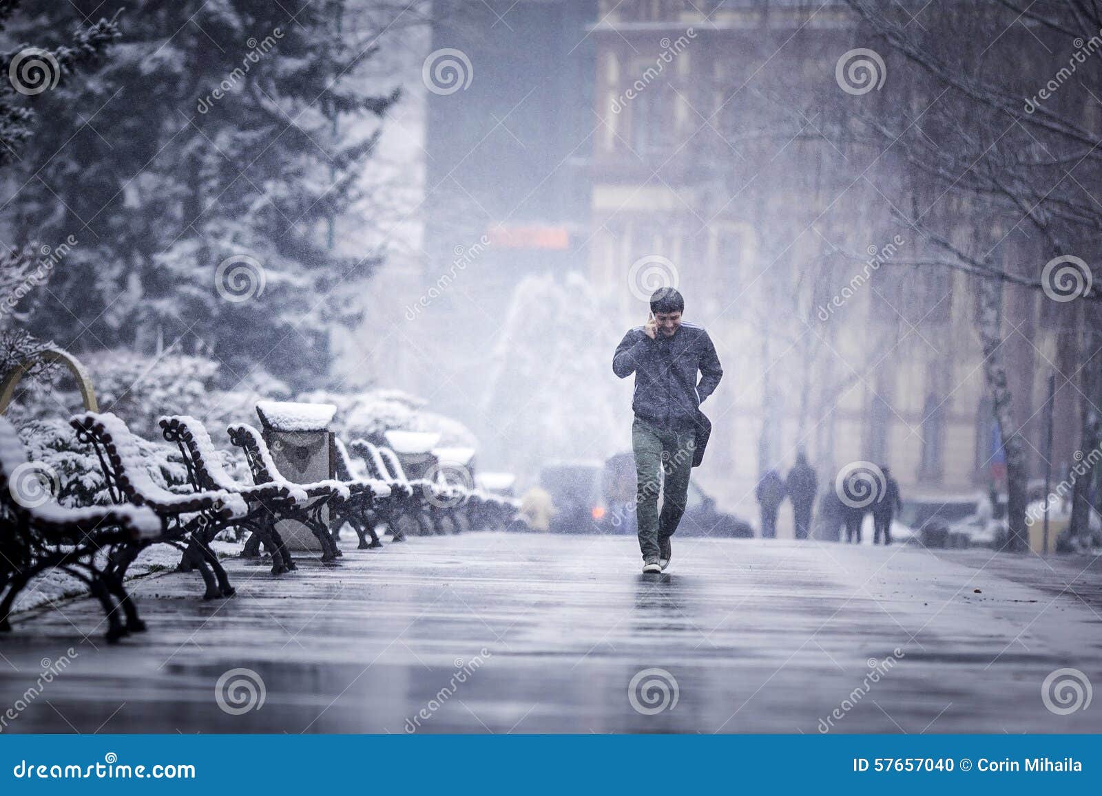 A Man Walking Alone in a Cold Winter Talking on the Phone Editorial ...