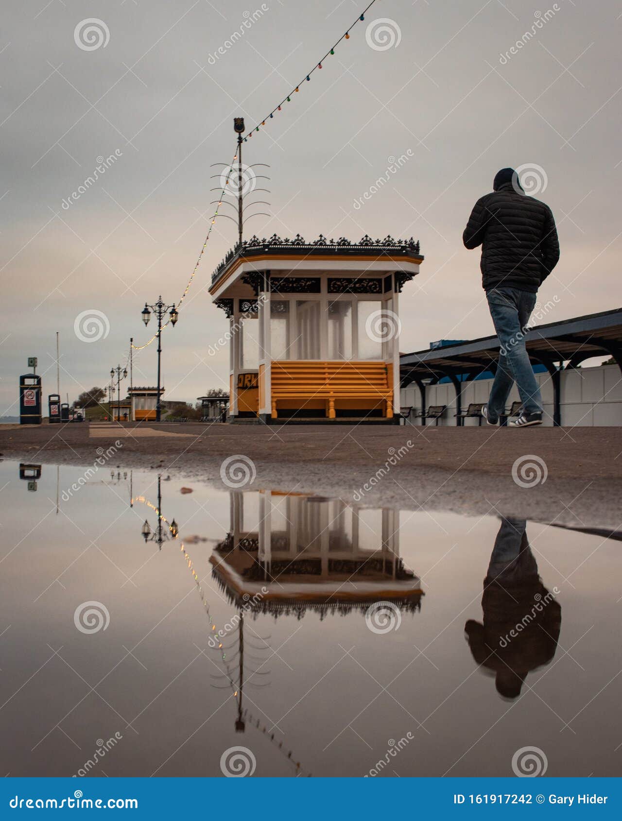 A Man Walking Along a Beach Reflecting in Flood Waters Stock Photo ... A Man Walking Along a Beach Reflecting in Flood Waters Stock Photo ...