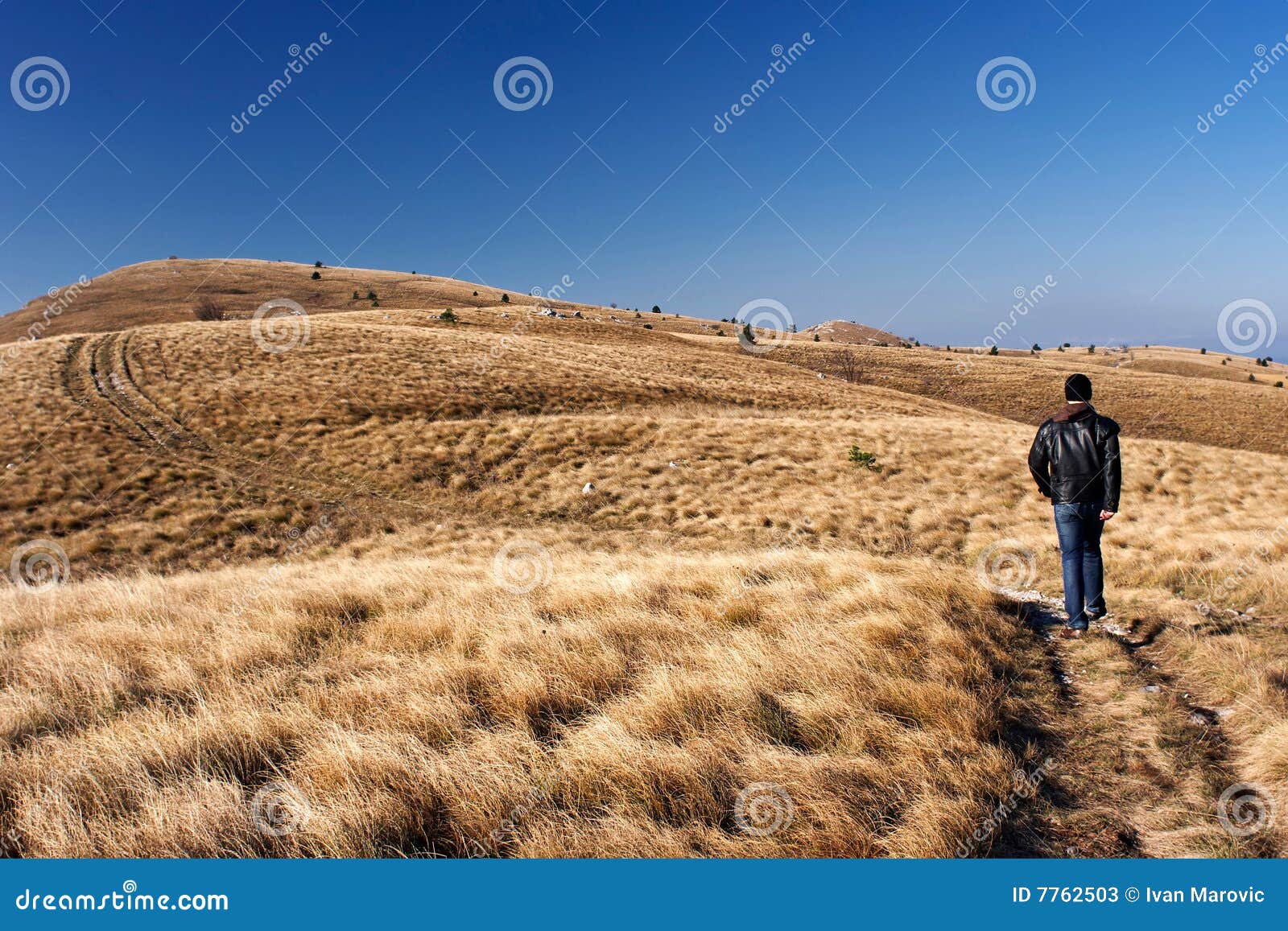 Man Walking Along Mountain Path Stock Image - Image of rough, brown ...