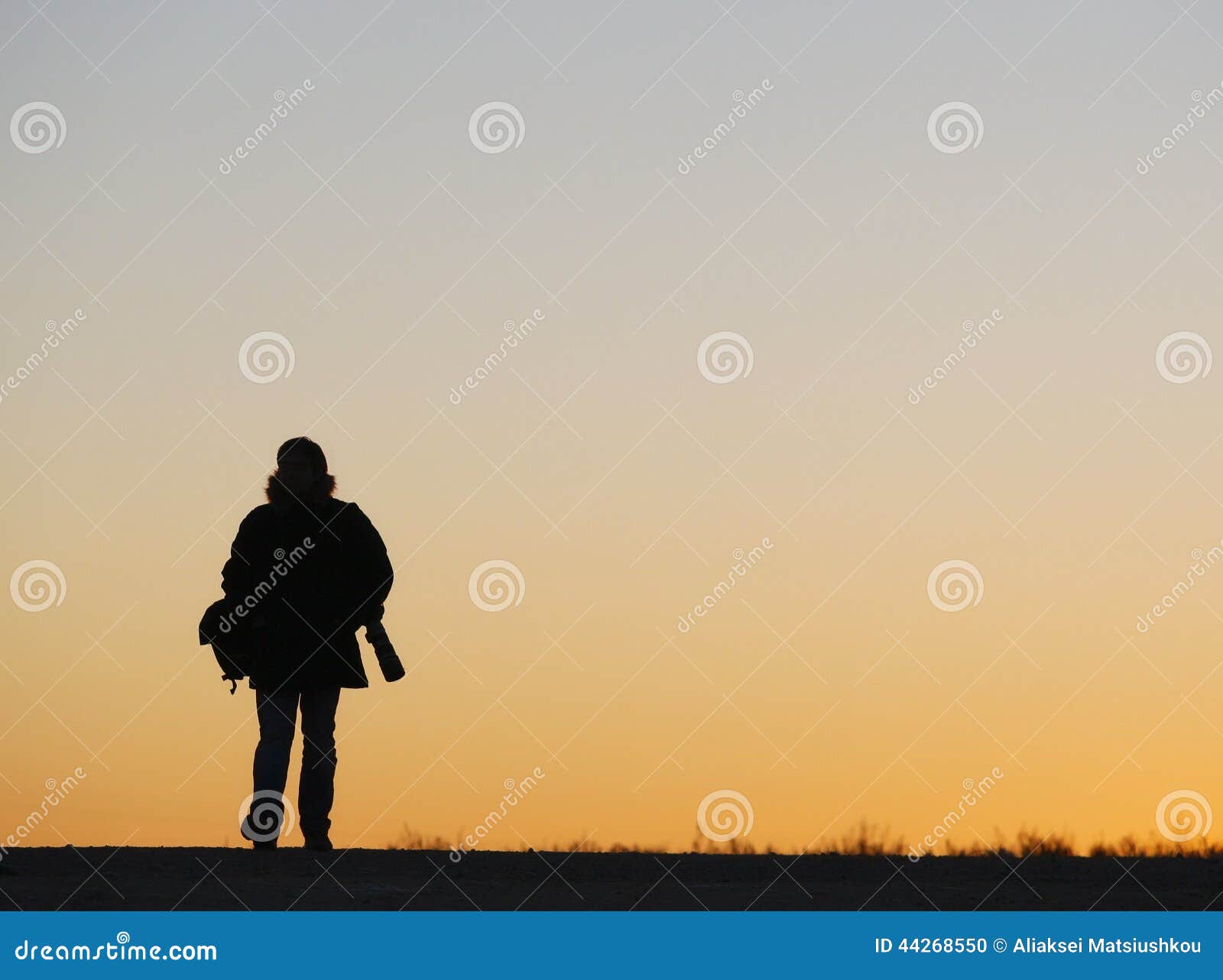 Man Walking Along the Road, Backlit at Sunset Stock Photo - Image of ...