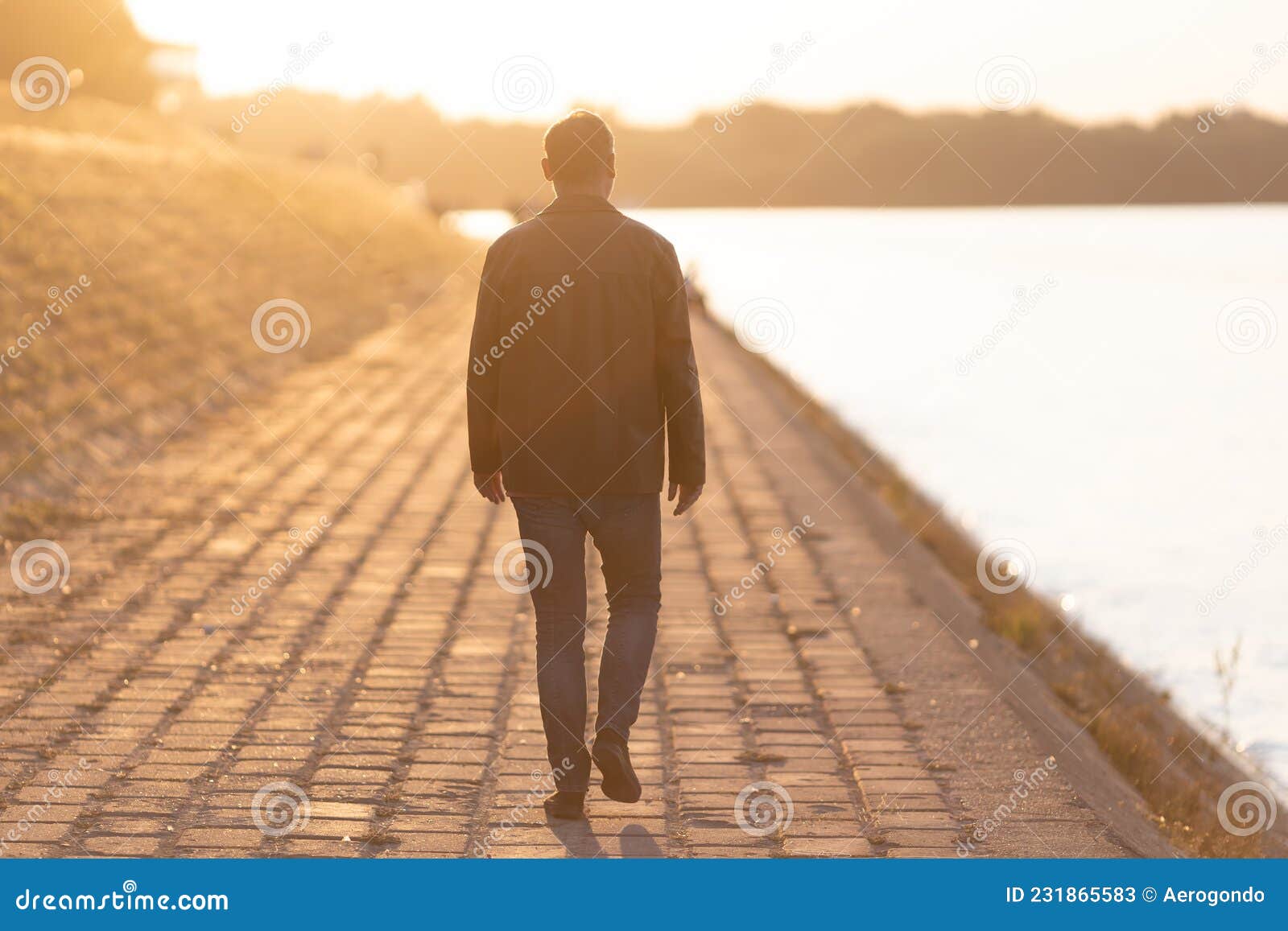 Man Walking Away into Sunset Stock Image - Image of freedom, dusk ...