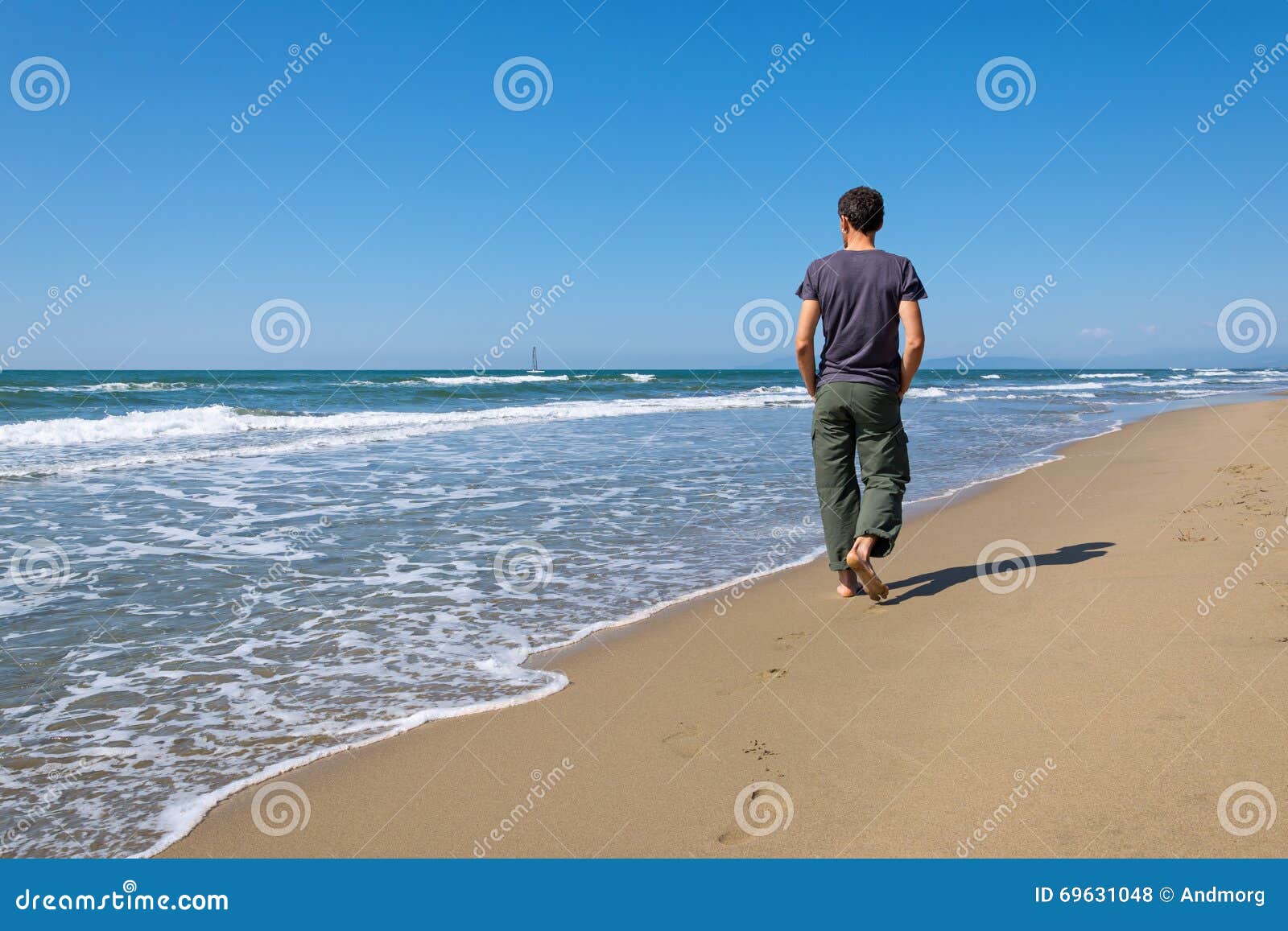 Man walking on the beach stock photo. Image of outdoor - 69631048