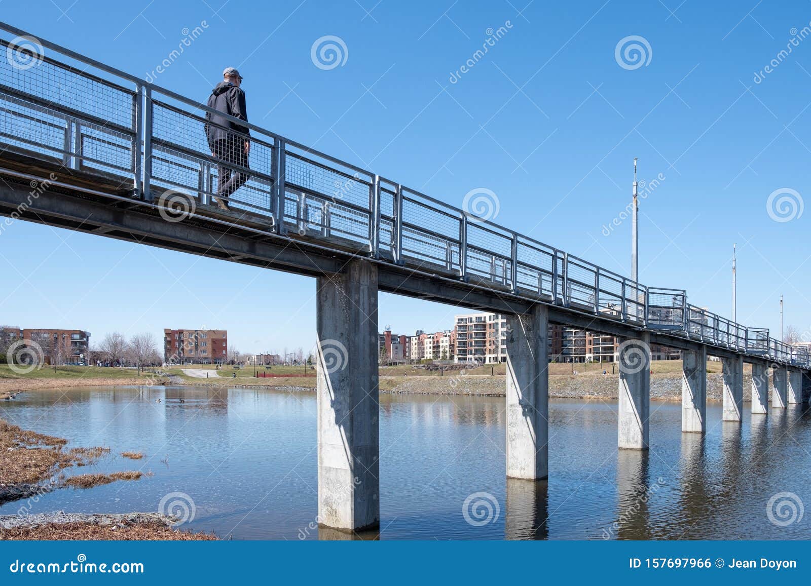 Man walking on a bridge stock photo. Image of landmark - 157697966