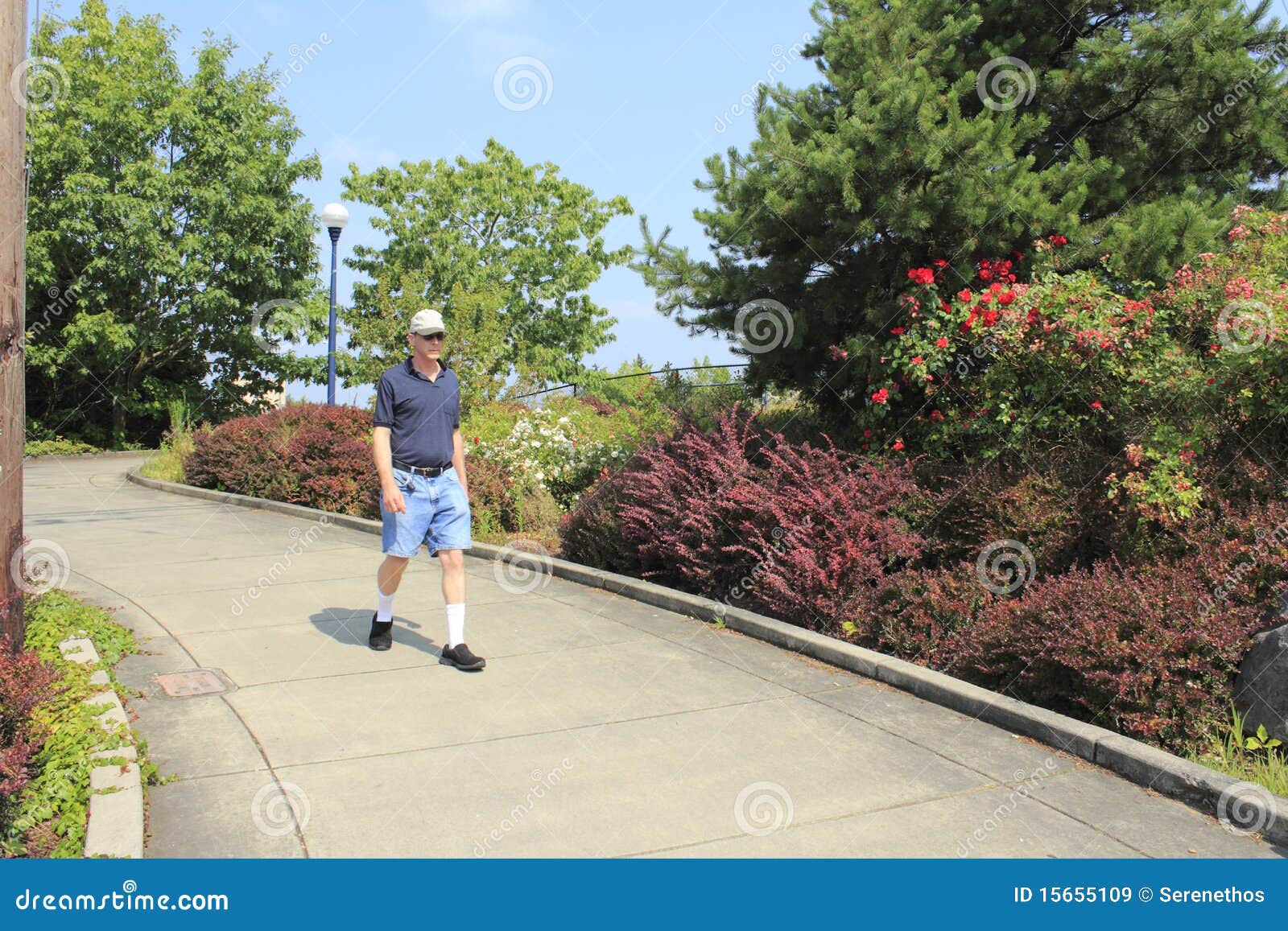 Man Walking Down Sloped Sidewalk Stock Image - Image of caucasian, path ...