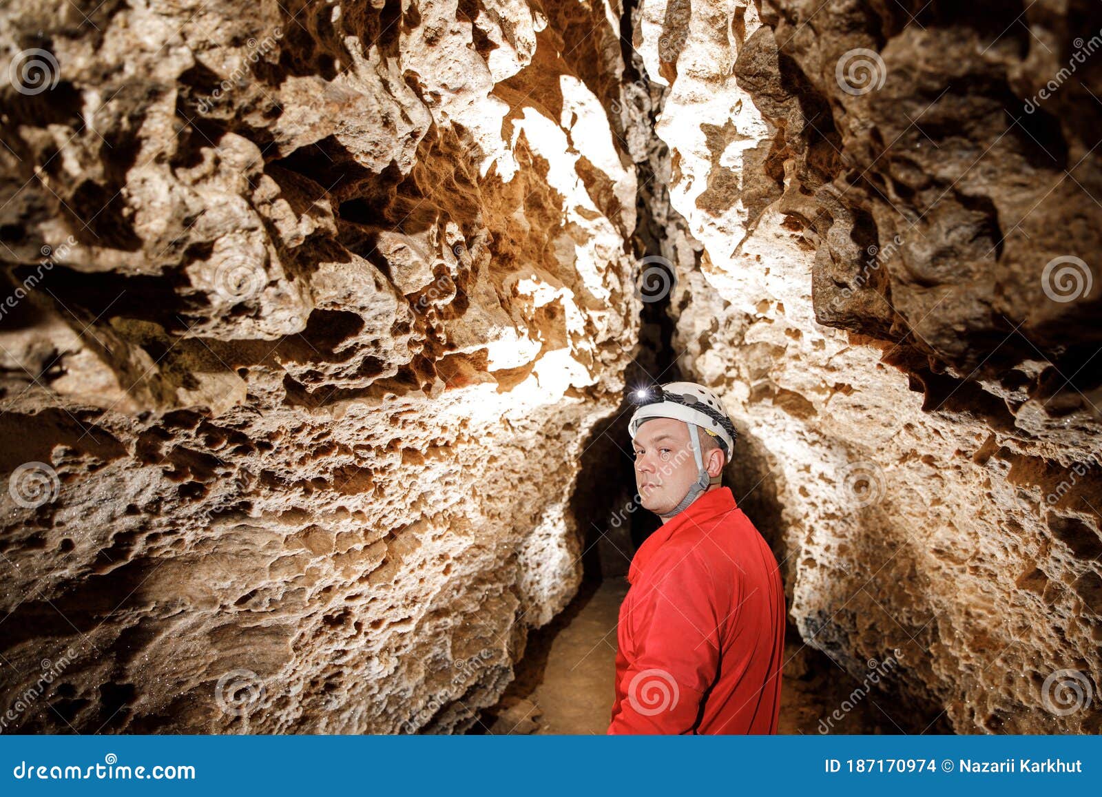 Man Walking and Exploring Dark Cave with Light Headlamp Stock Photo ...