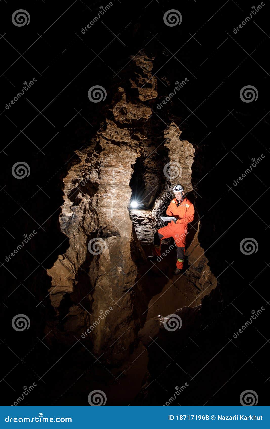 Man Walking and Exploring Dark Cave with Light Stock Photo - Image of ...