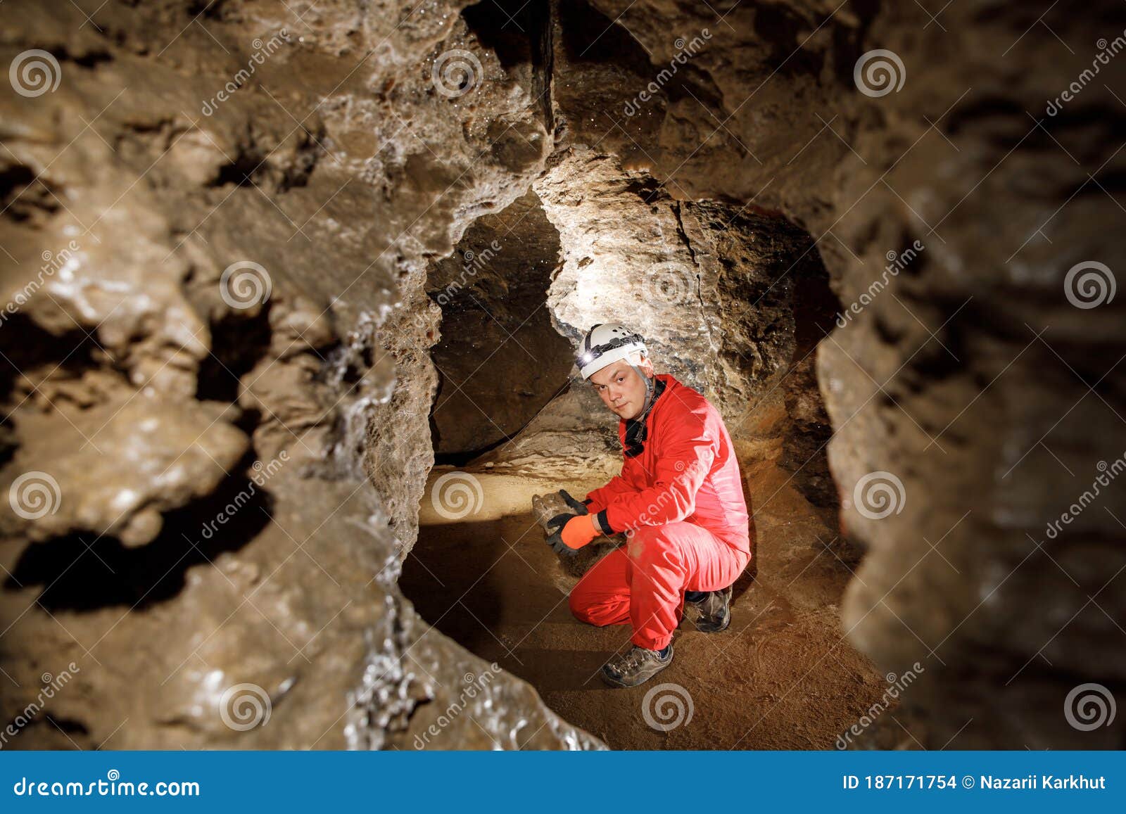 Man Walking and Exploring Dark Cave with Light Headlamp Underground ...
