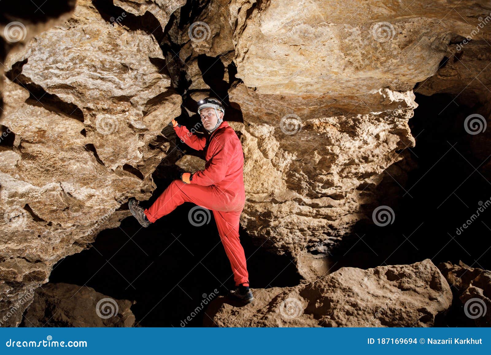 Man Walking and Exploring Dark Cave with Light Headlamp Underground ...