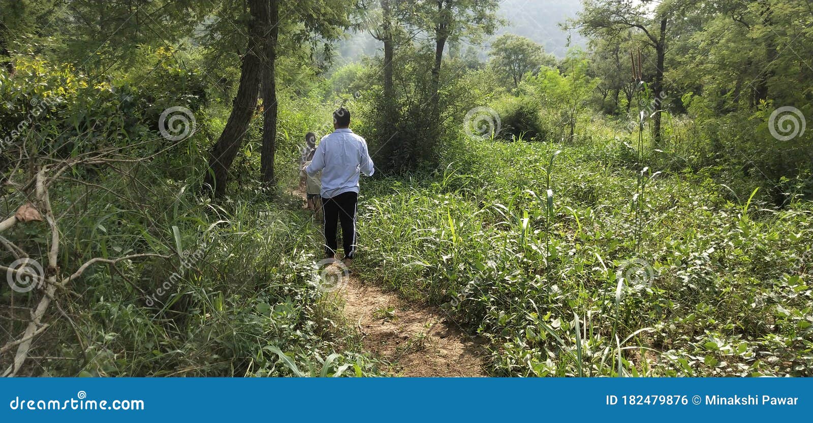 Man walking in field stock photo. Image of agriculture - 182479876