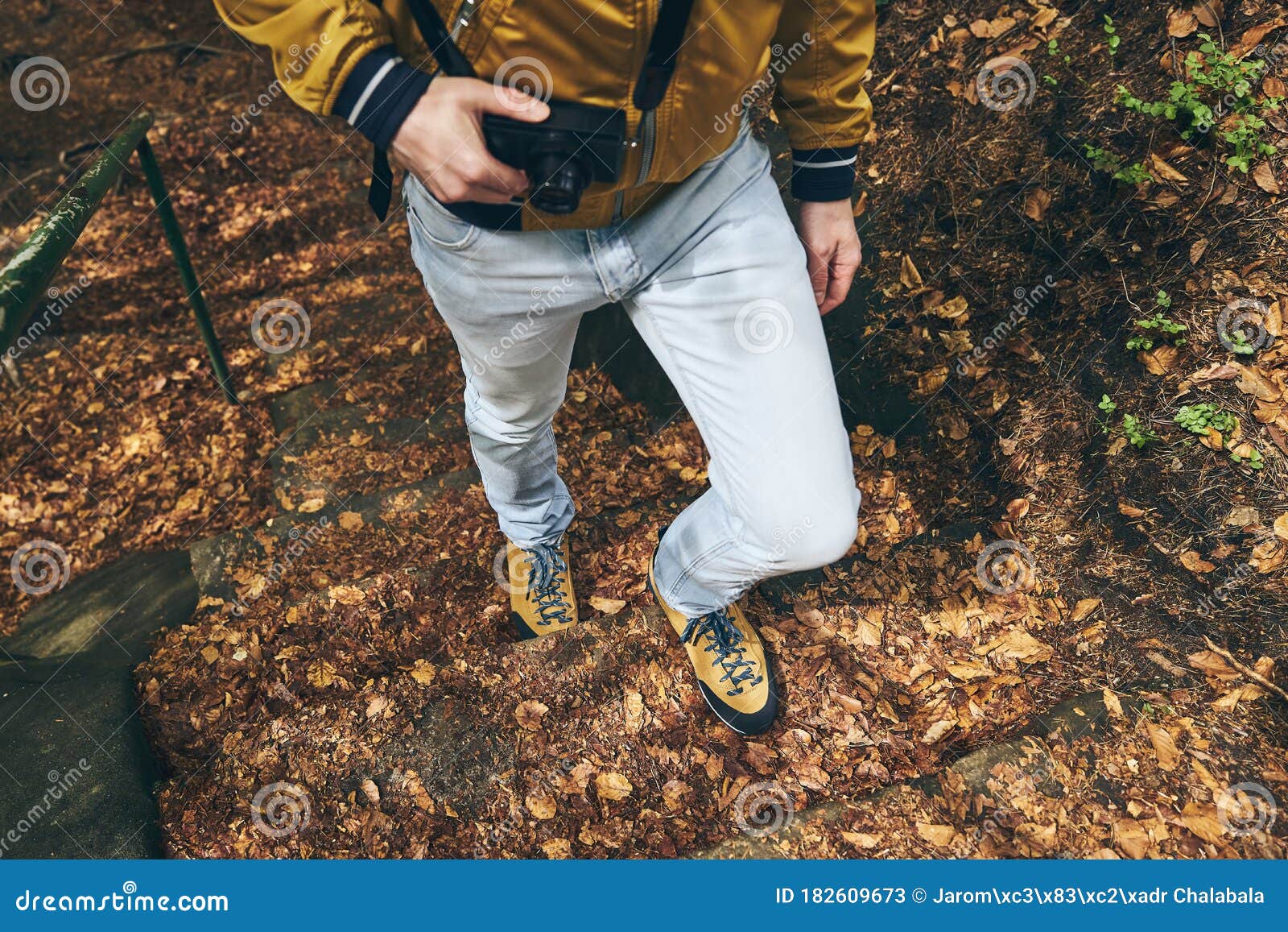 Man walking on footpath stock image. Image of camera - 182609673