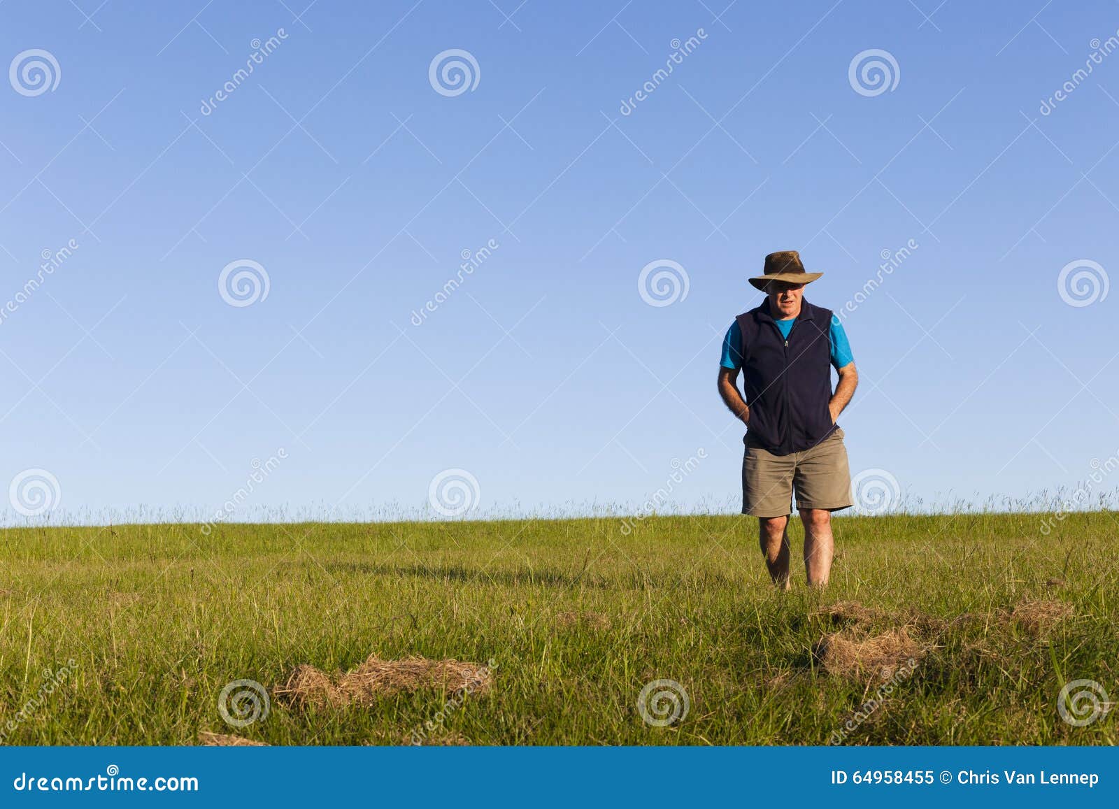 Man Walking Grass Field stock image. Image of hiking - 64958455