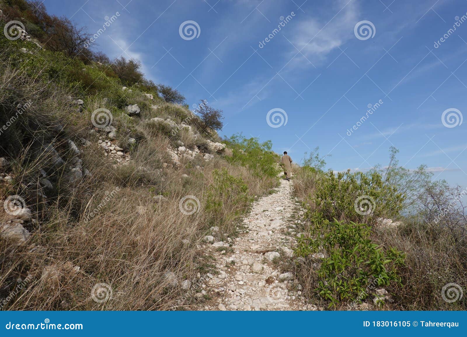 A Man Walking on a Hilly Trek Stock Image - Image of ridge, plateau ...