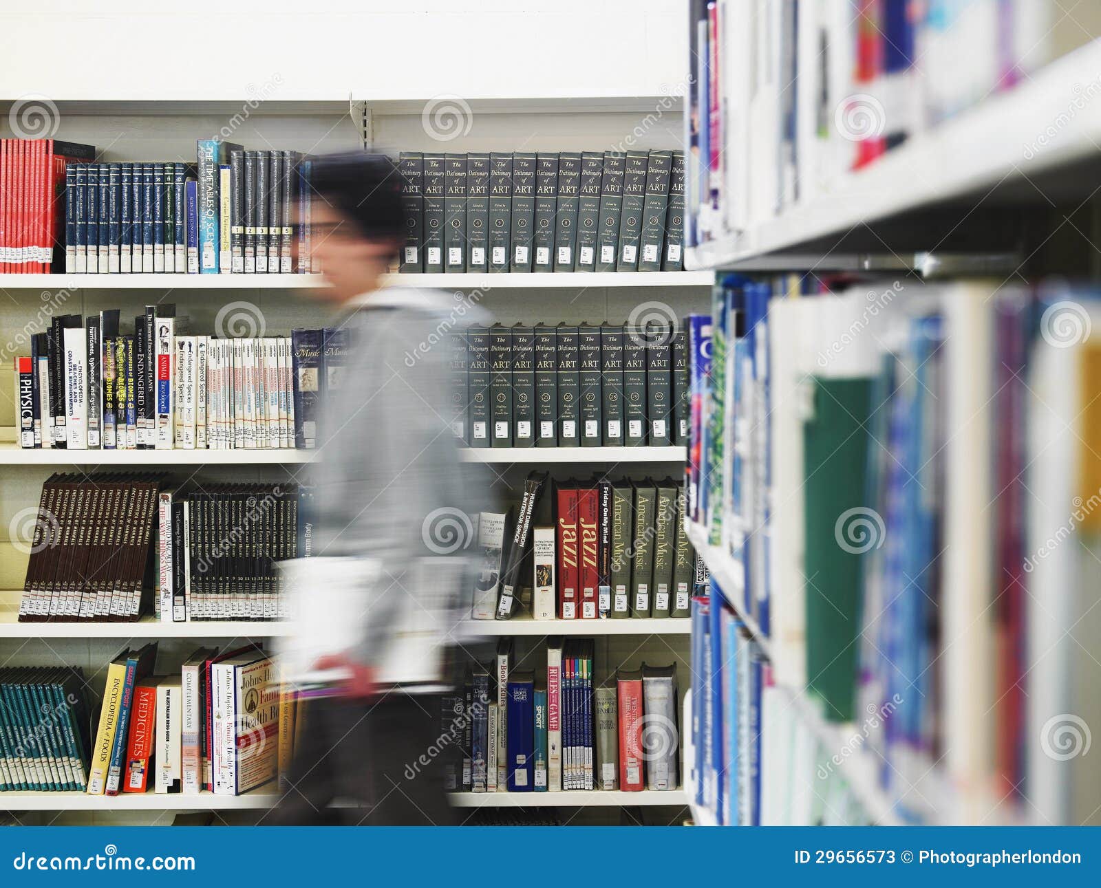 Man Walking in Library stock image. Image of educate - 29656573