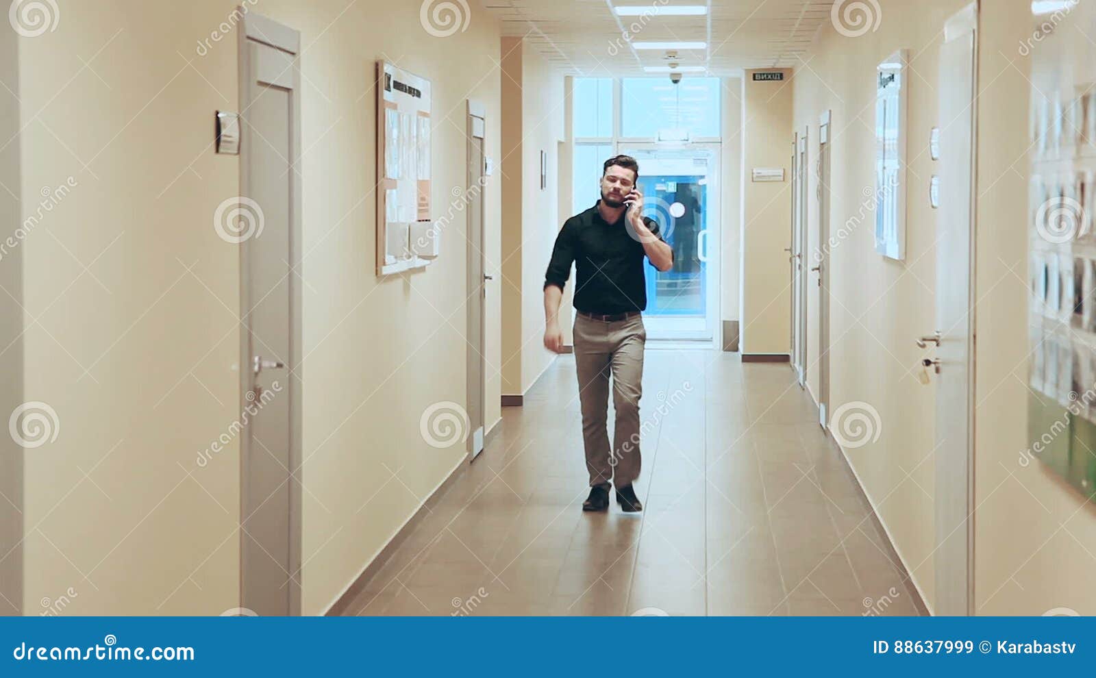 Man Walking through a Long Corridor Stock Video - Video of corridor ...