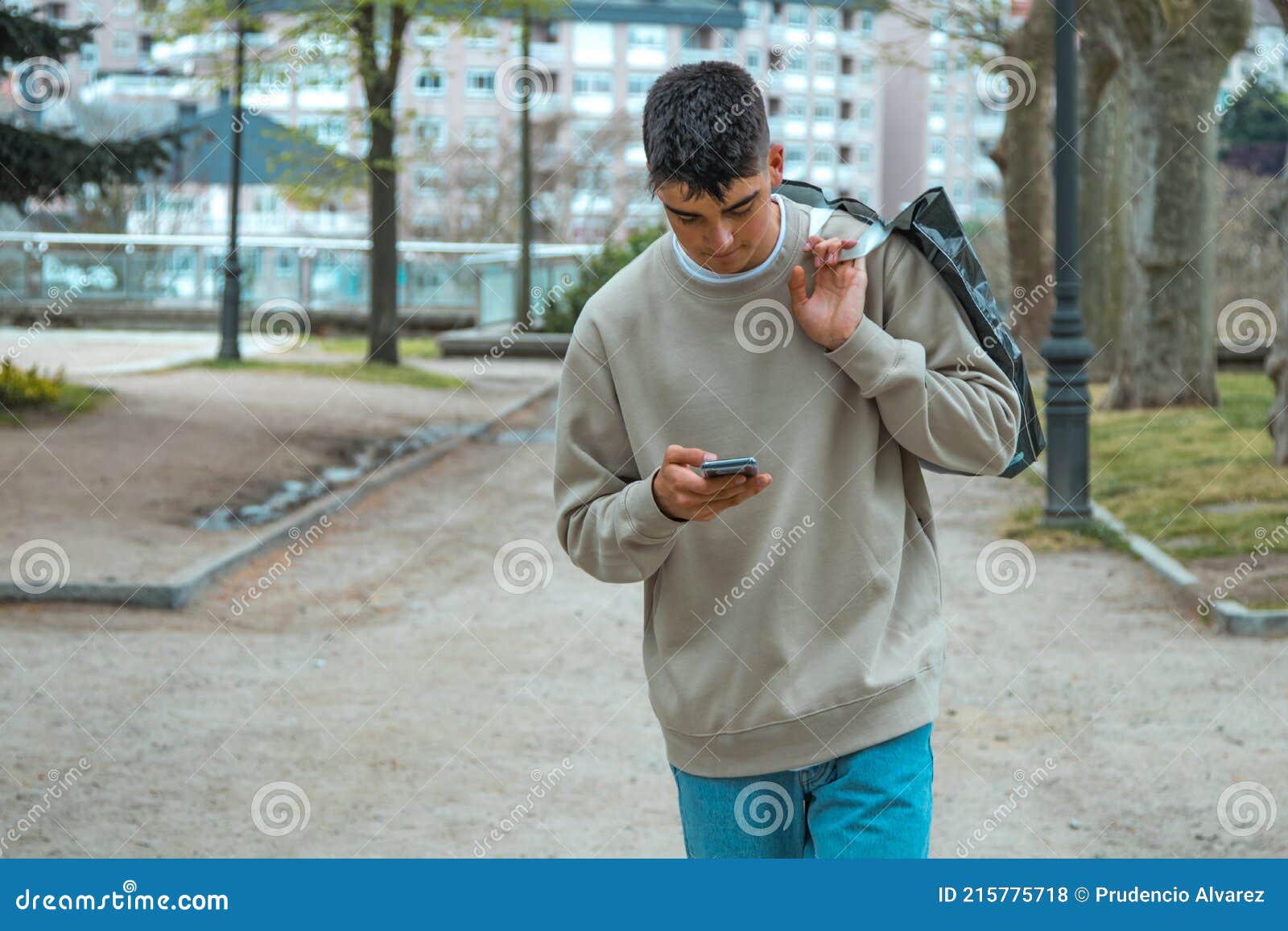 Man Walking Looking at Mobile Phone Stock Photo - Image of modern ...