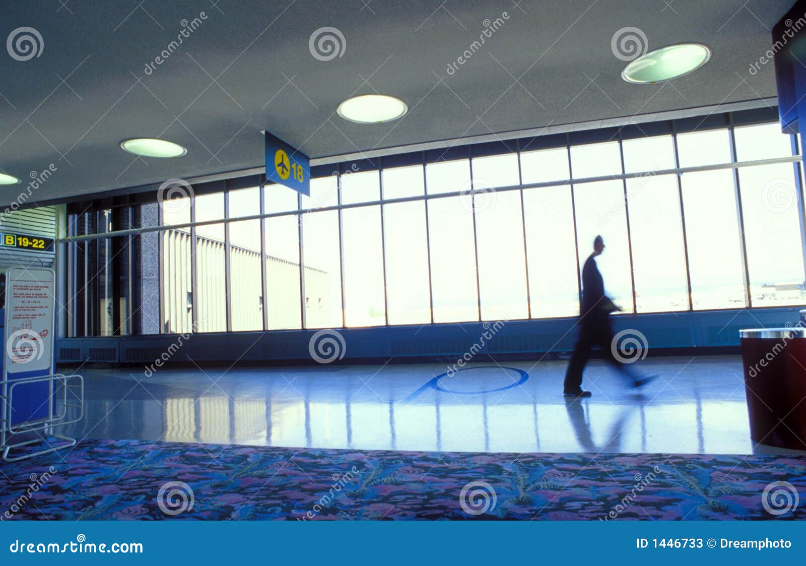 Man walking near windows stock image. Image of corridor - 1446733