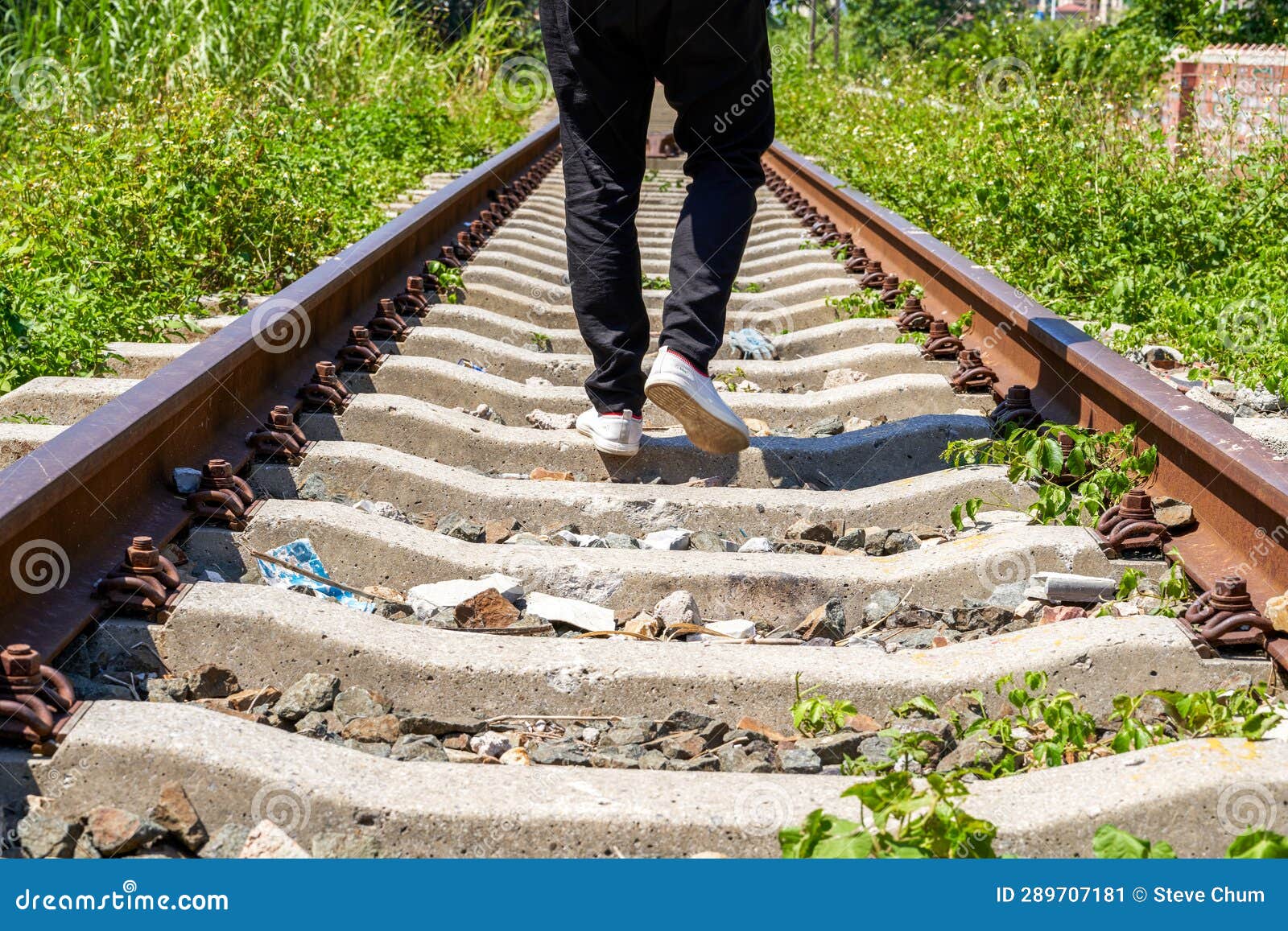 A Man Walking on Old Rusty Railway Tracks Outdoors Stock Image - Image ...
