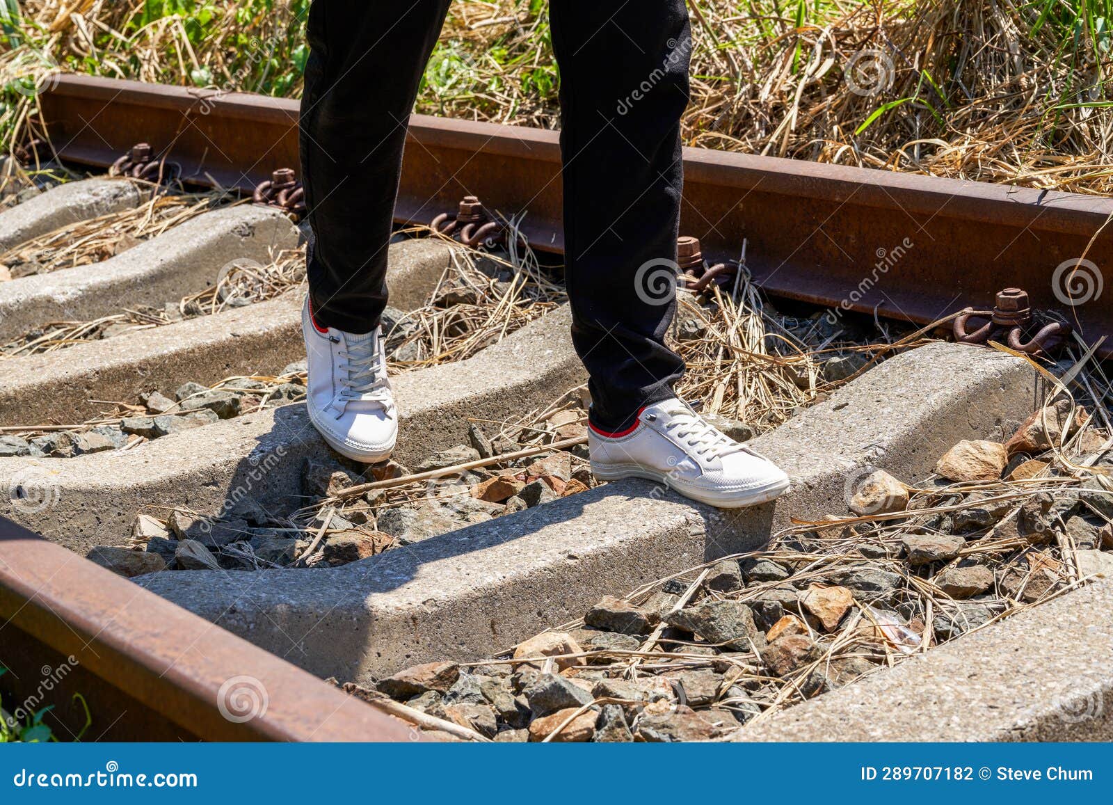 A Man Walking on Old Rusty Railway Tracks Outdoors Stock Photo - Image ...