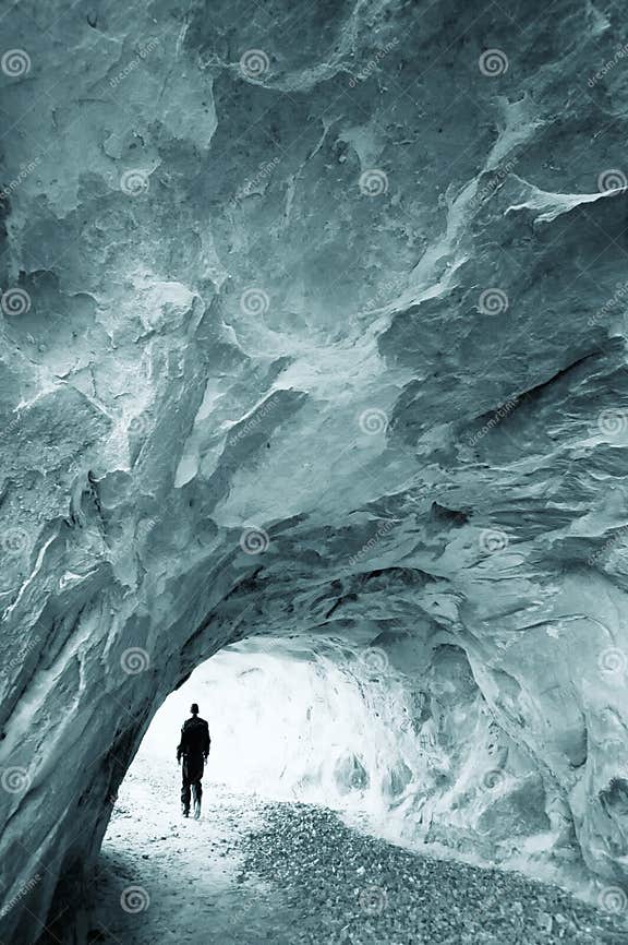Man walking out of a cave stock image. Image of geologic - 17824441