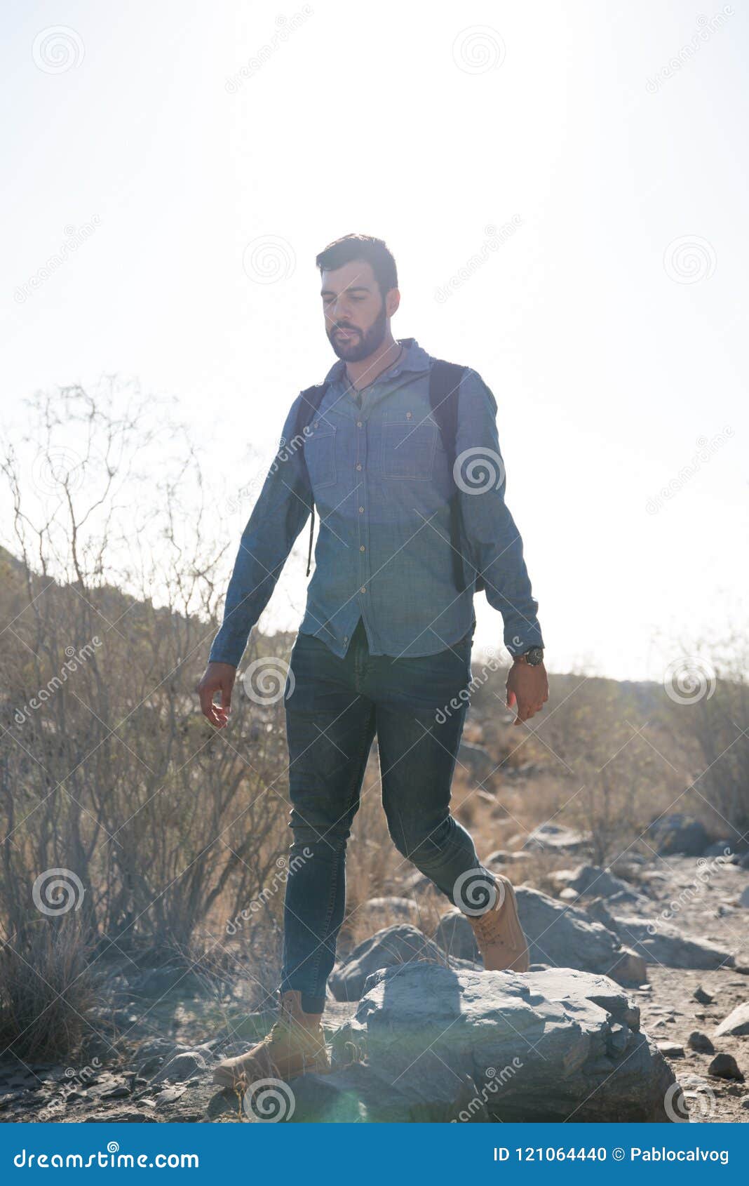 Man Walking Over Rocks in the Desert Stock Photo - Image of adult ...