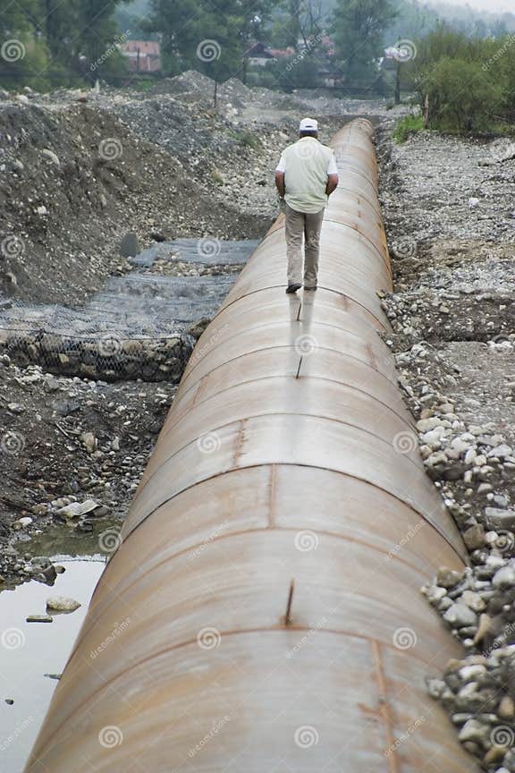 Man walking on pipeline stock photo. Image of inspecting - 3842352