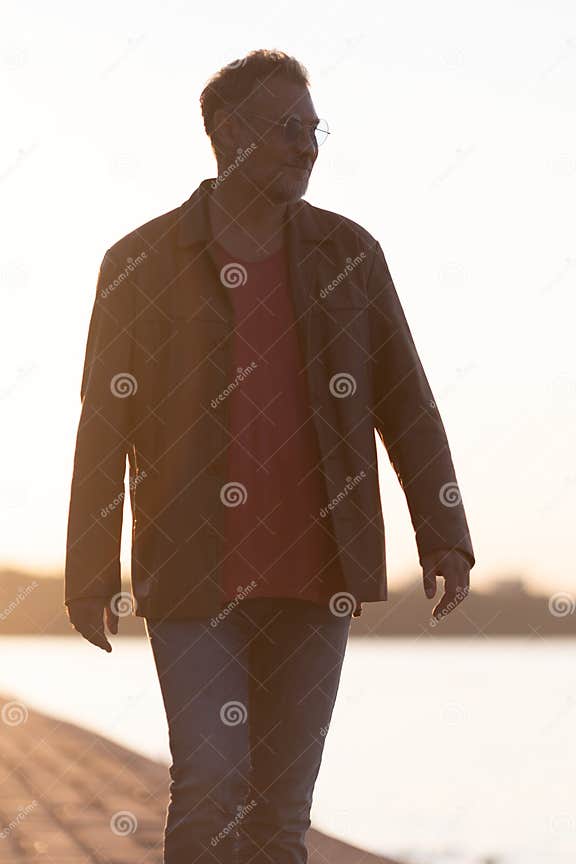 Single Man Walking on River Edge Stock Photo - Image of memory ...