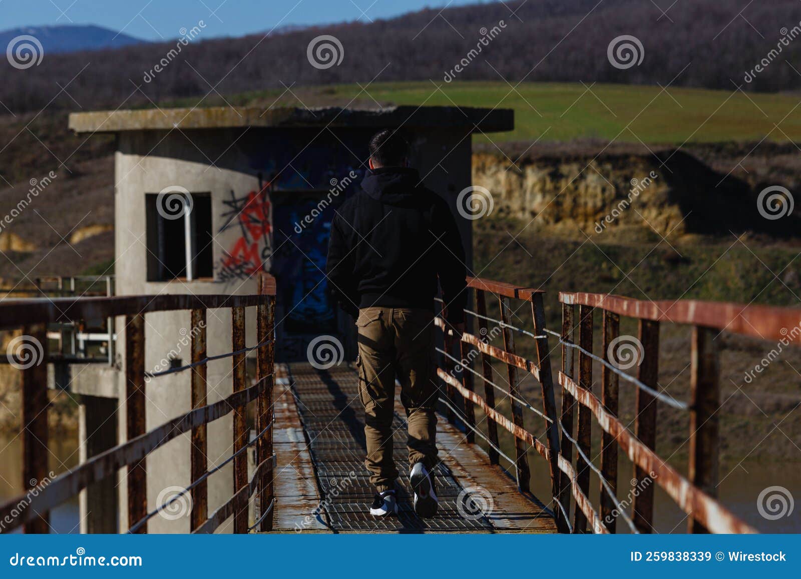 Man Walking by a Rusty Bridge Stock Image - Image of people, outside ...