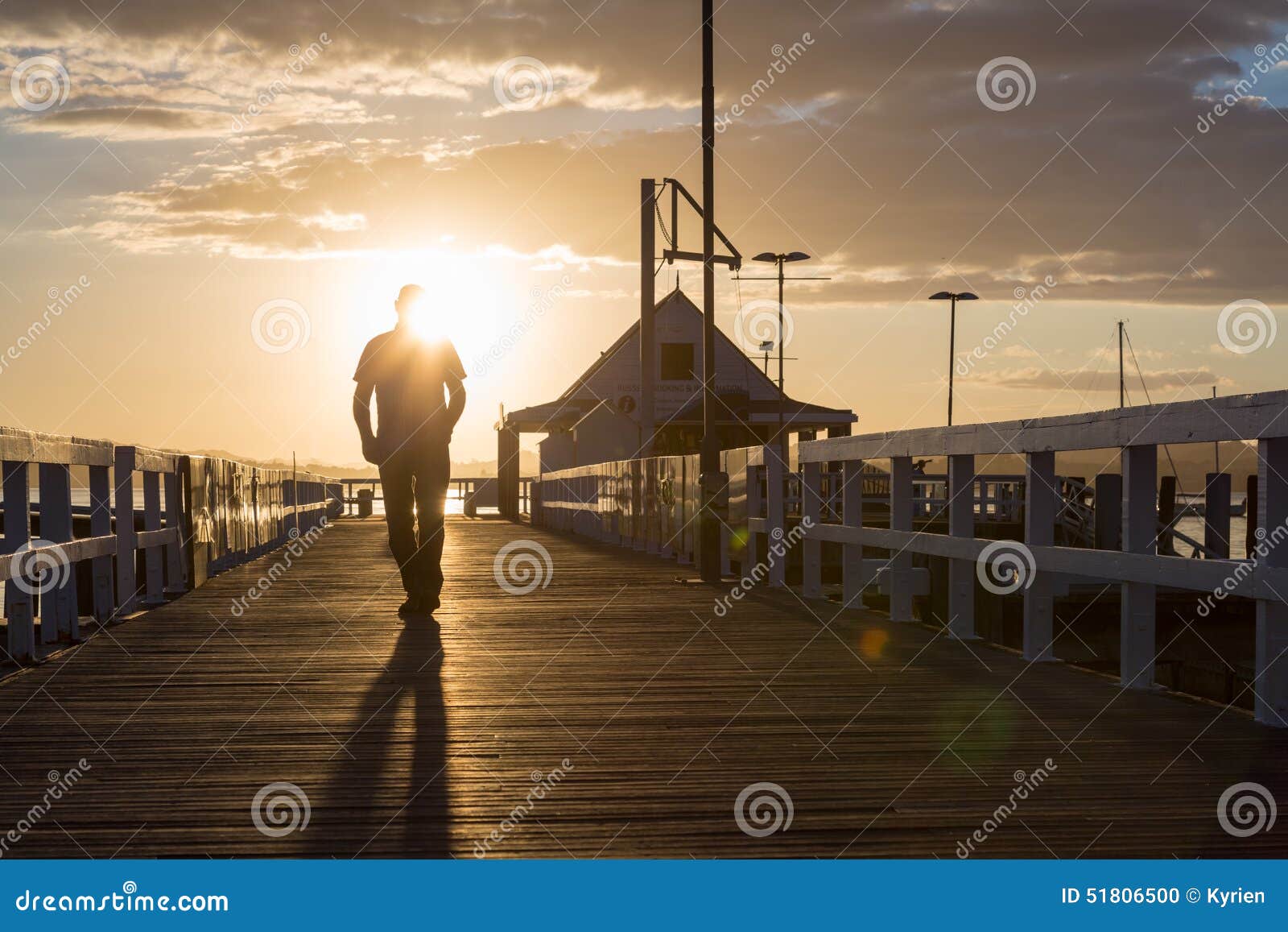 A Man Walking at Sunset at the Pier Stock Photo - Image of dawn, beauty ...