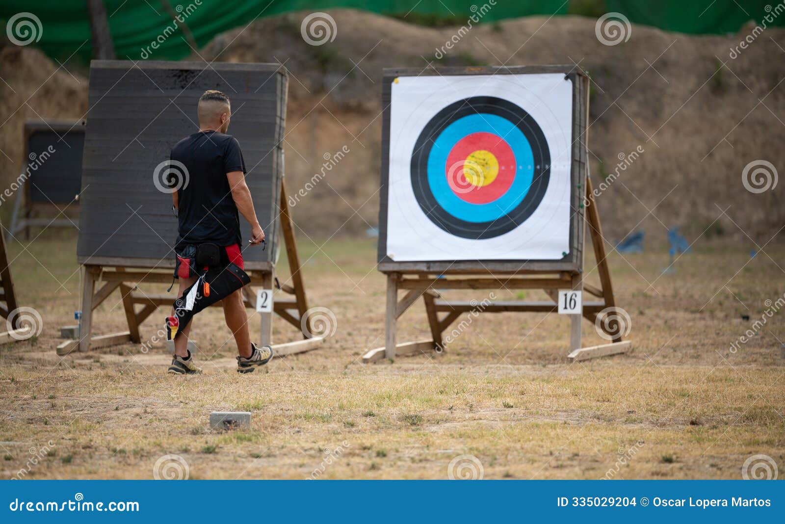 A Man is Walking Towards a Target with a Bow and Arrow Stock Photo ...