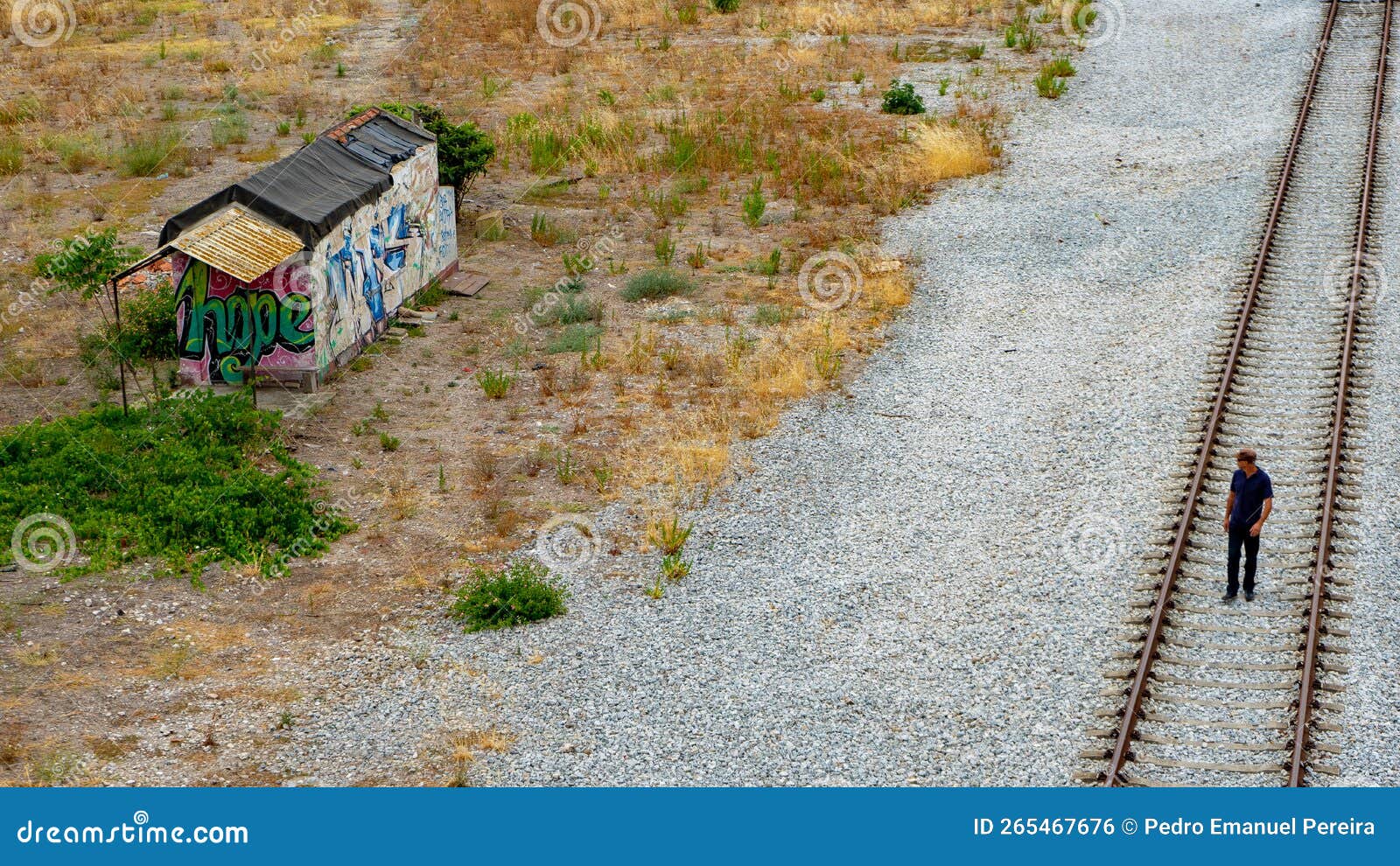 Man Walking on Train Tracks Looking at Home with Hope Written on the ...