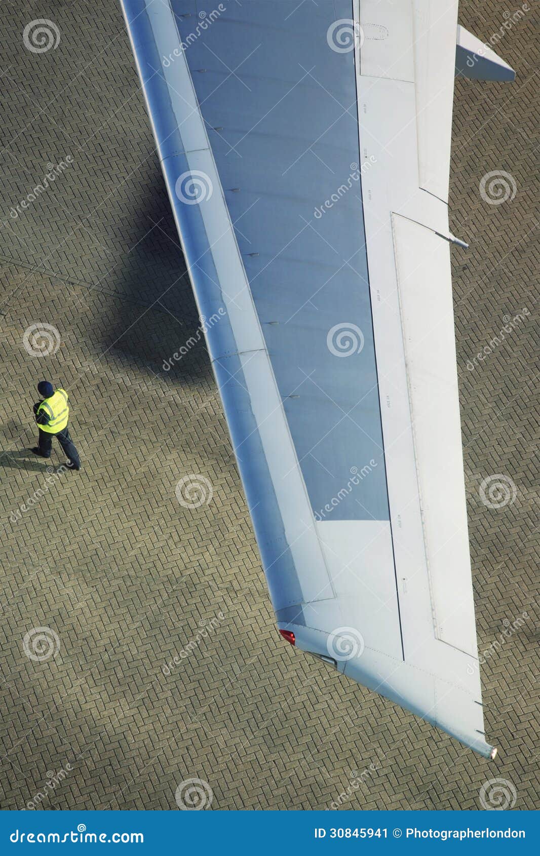 Man Walking Under Airplane Wing Elevated View Stock Image - Image of ...